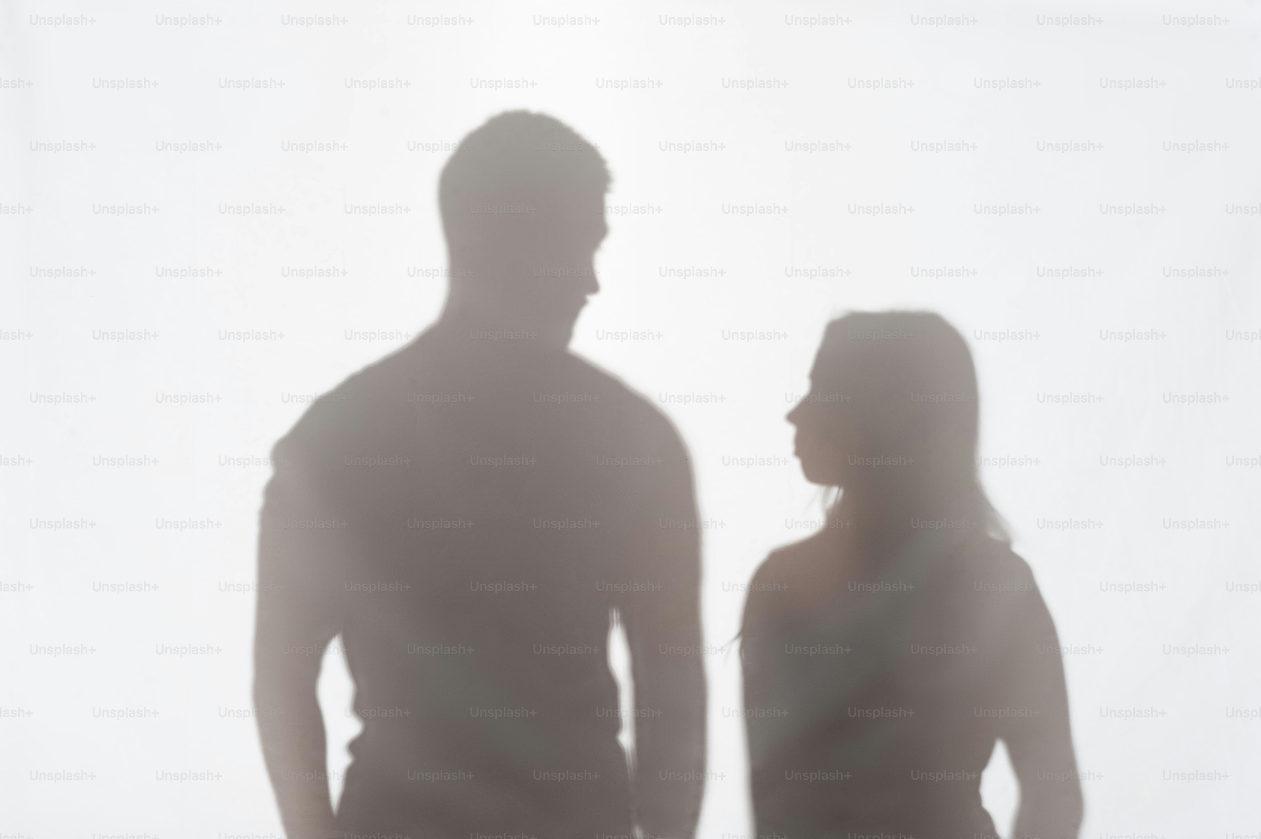 Silhouette of man and woman standing on white background and woman ...