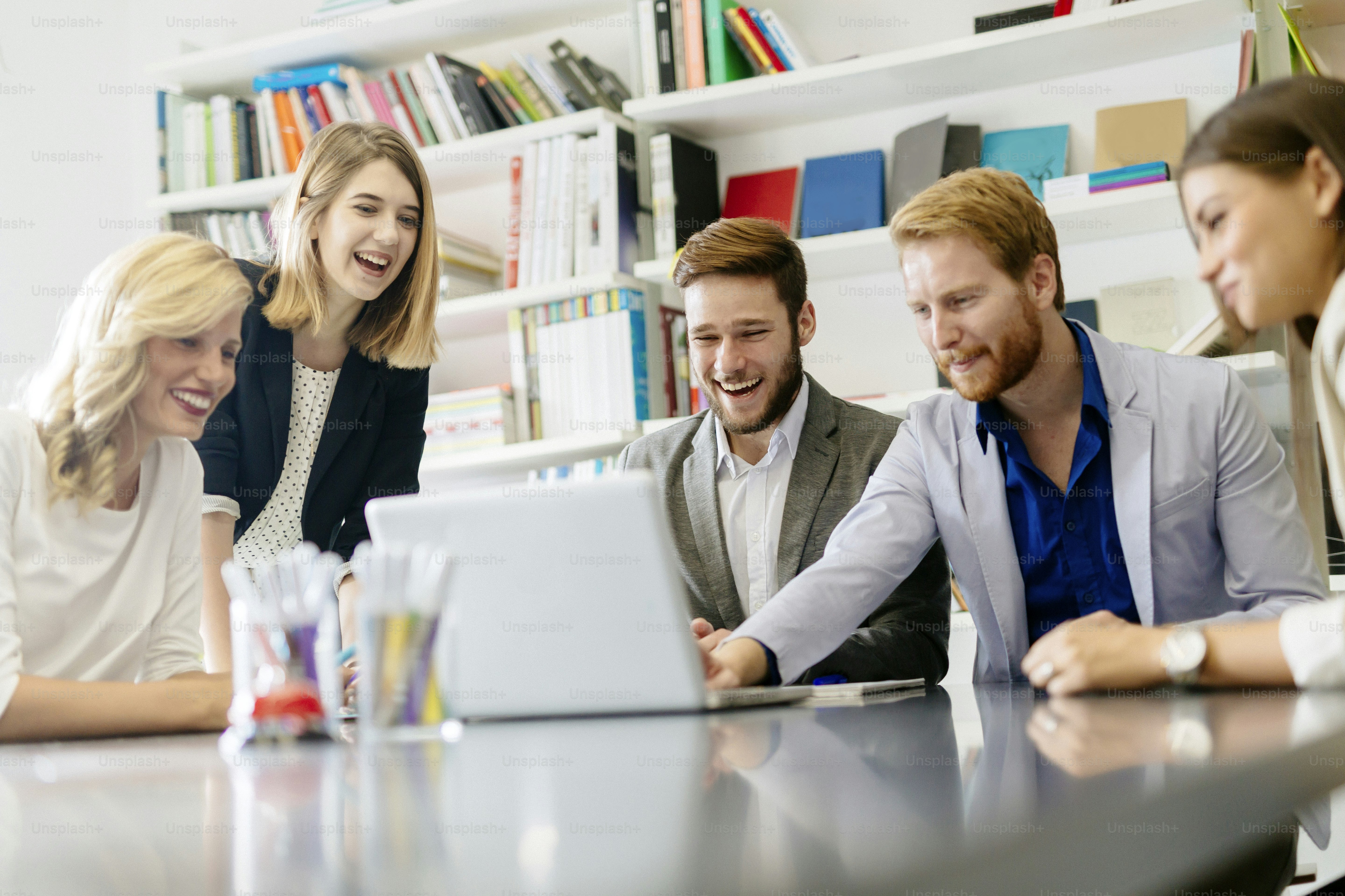 Team of creative people and designers in office smiling and being ...