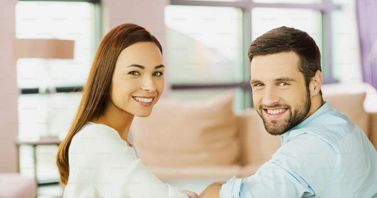 Rear View Of Beautiful Young Loving Couple Sitting Together On The Rear View Of Beautiful Young Loving Couple Sitting Together On The