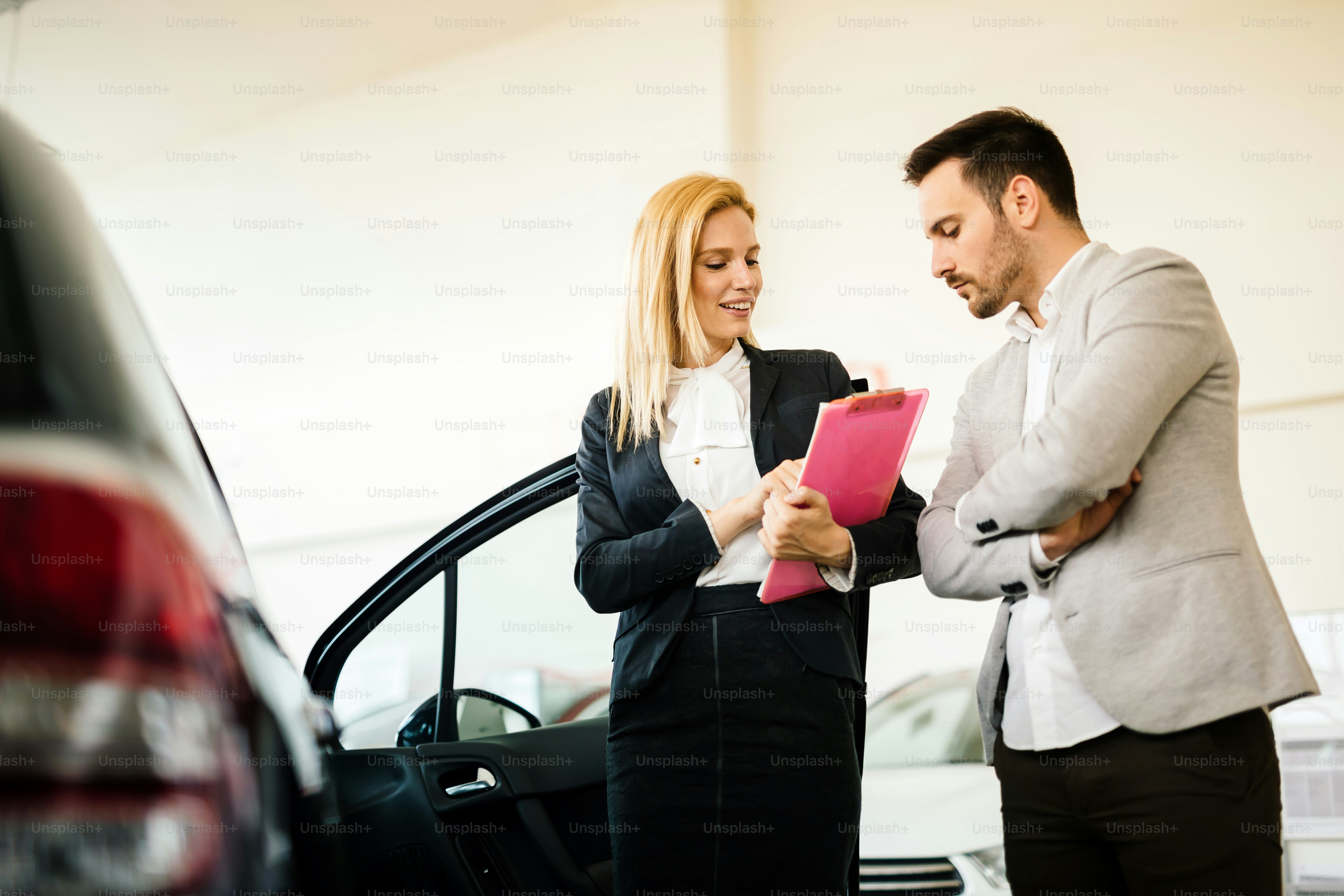 Customer looking for a car at dealership and customizing vehicle photo ...