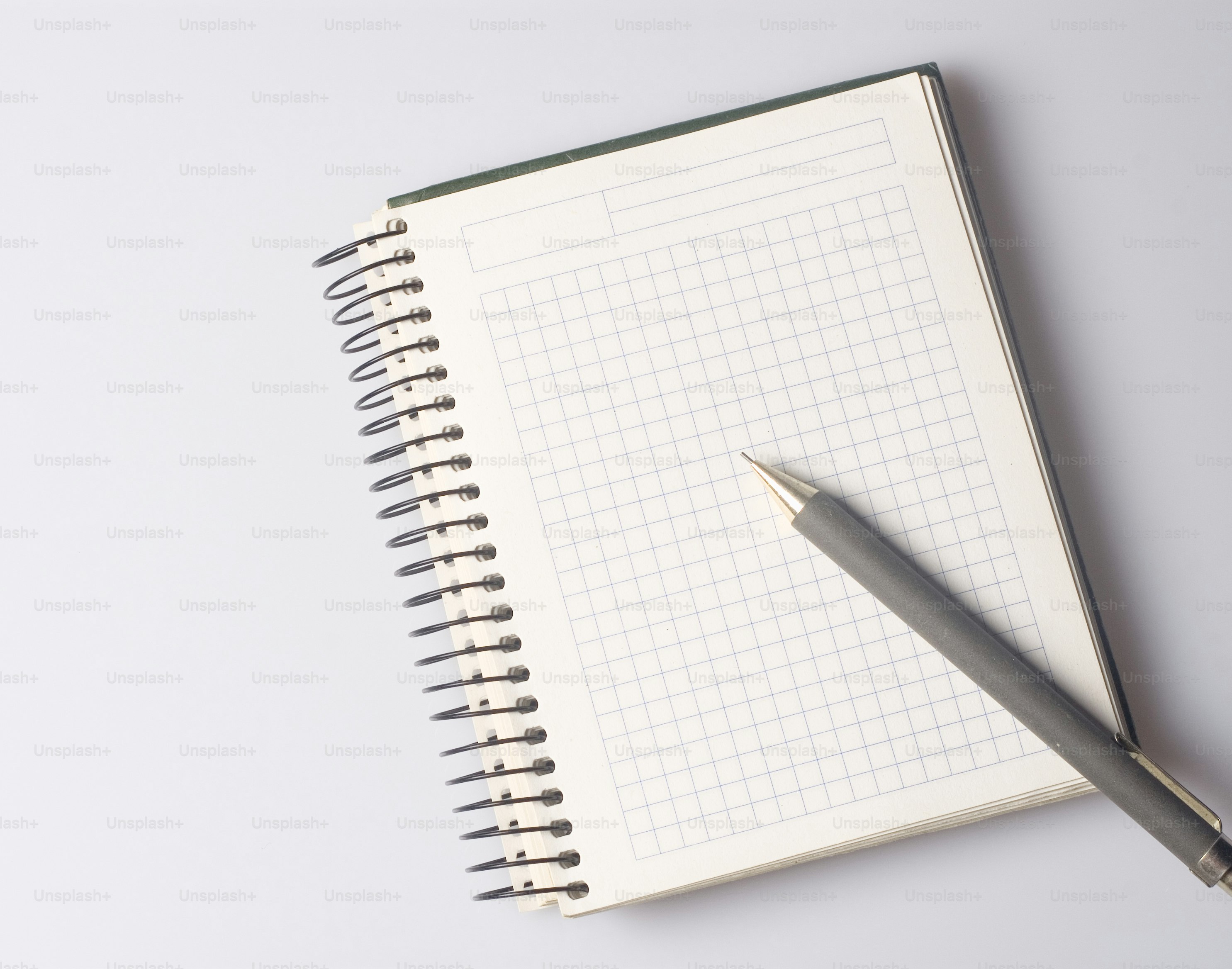 Overhead view woman making notes on notebook and working with laptop ...