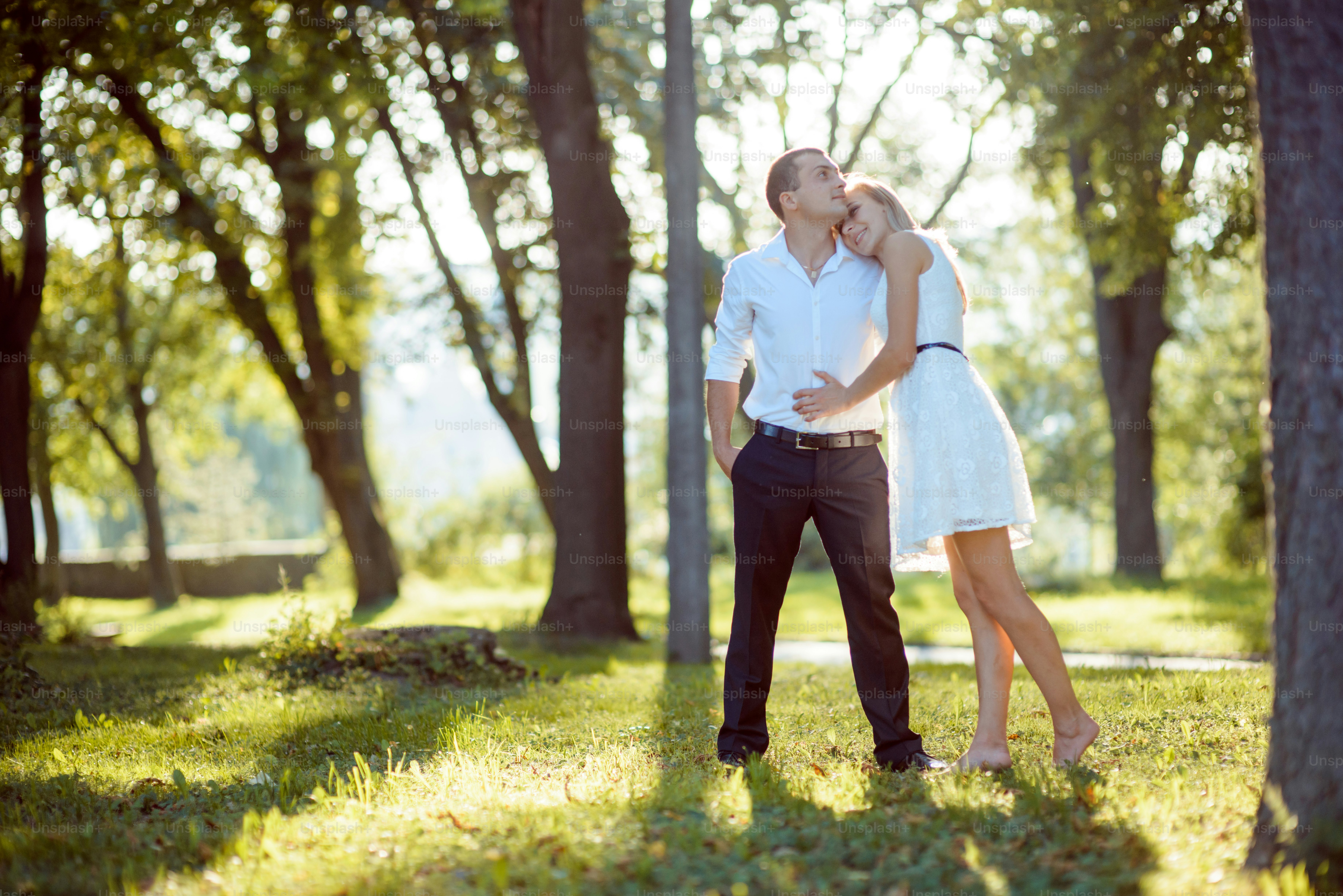 Romantic young couple stay together in park photo – People Image on ...