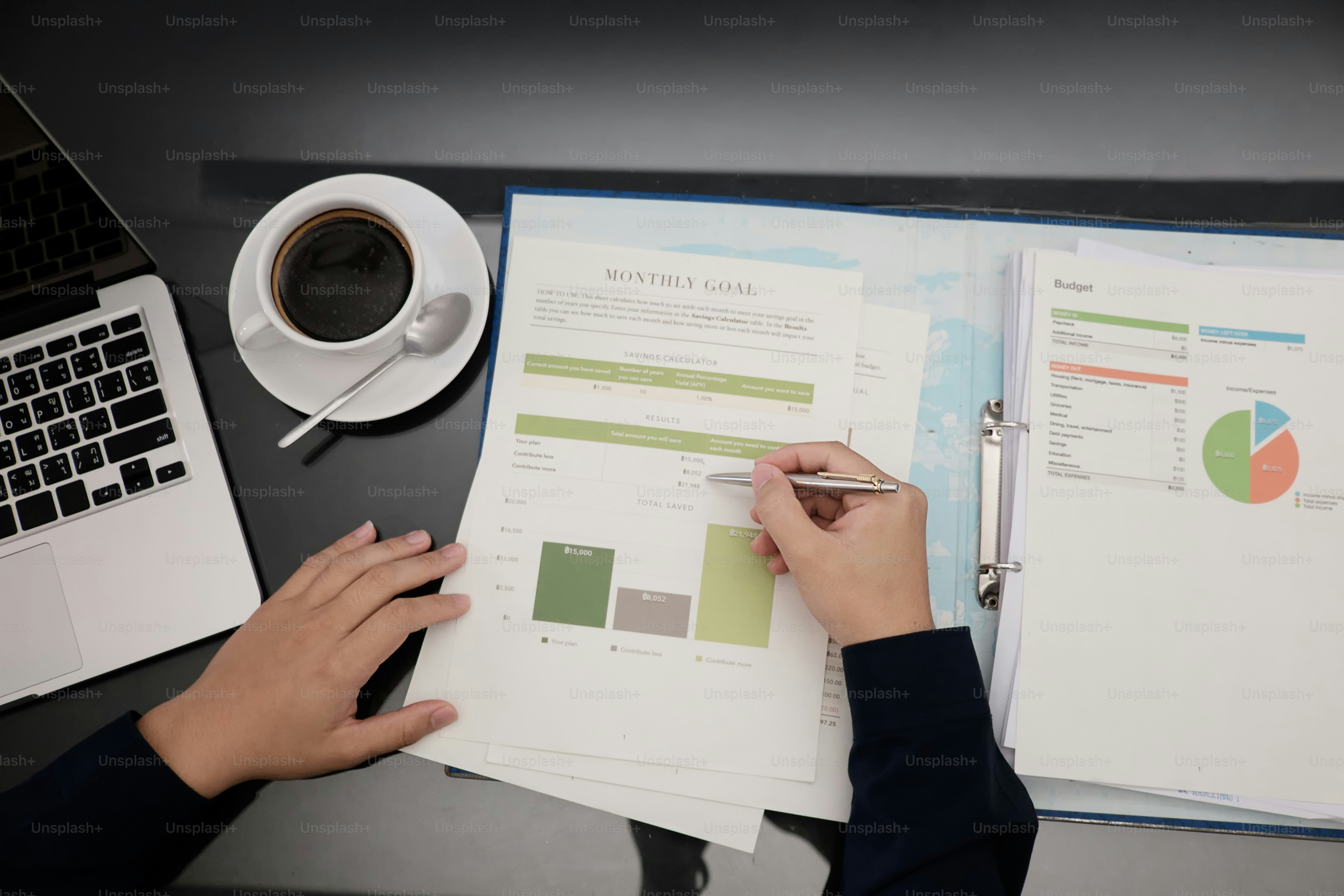 Businessman working at office desk with paperwork and other objects ...