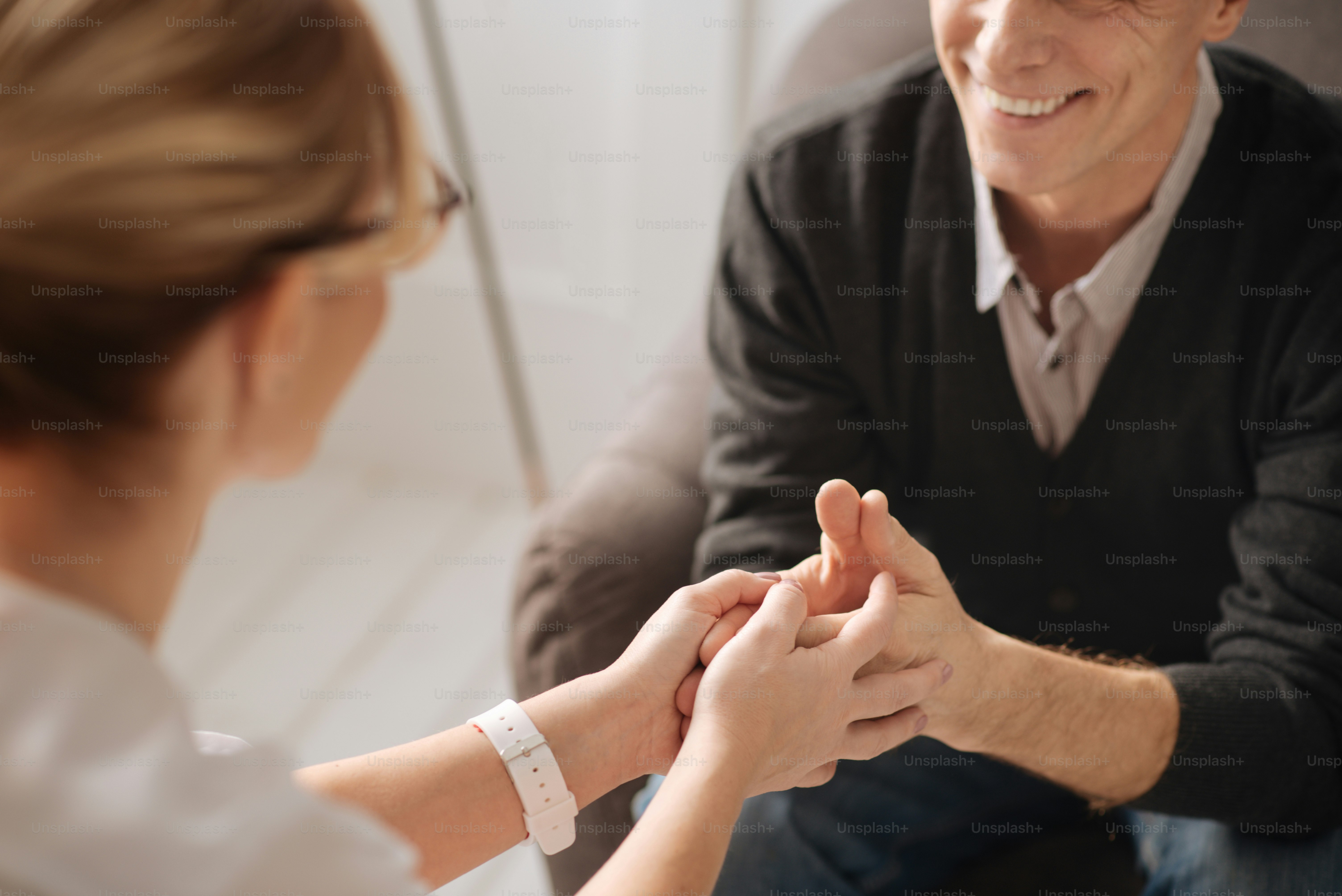Doctor patient relationships. Close up of hands of a therapist and a ...