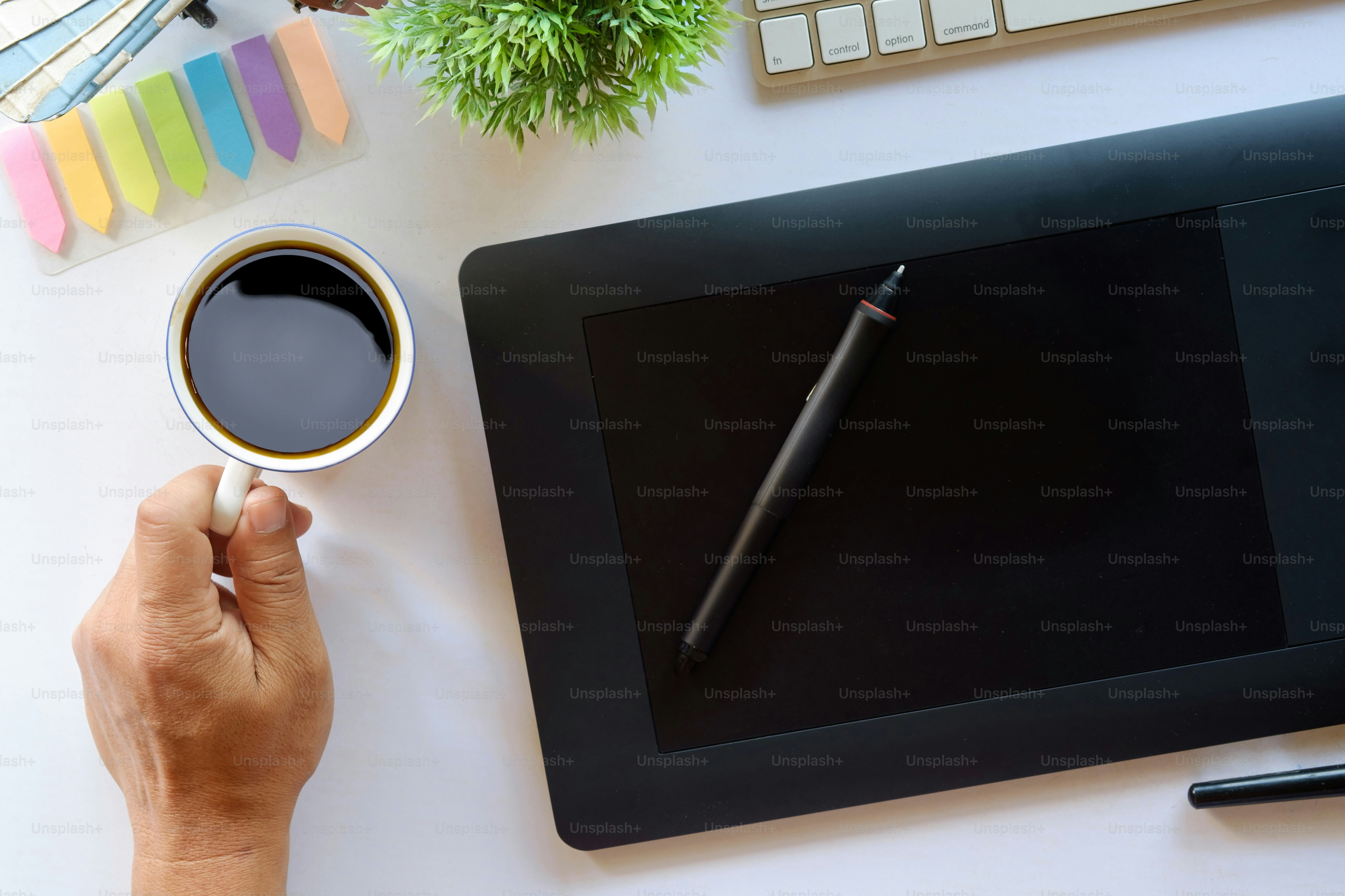 Graphic designer using graphics tablet to do his work at desk photo ...