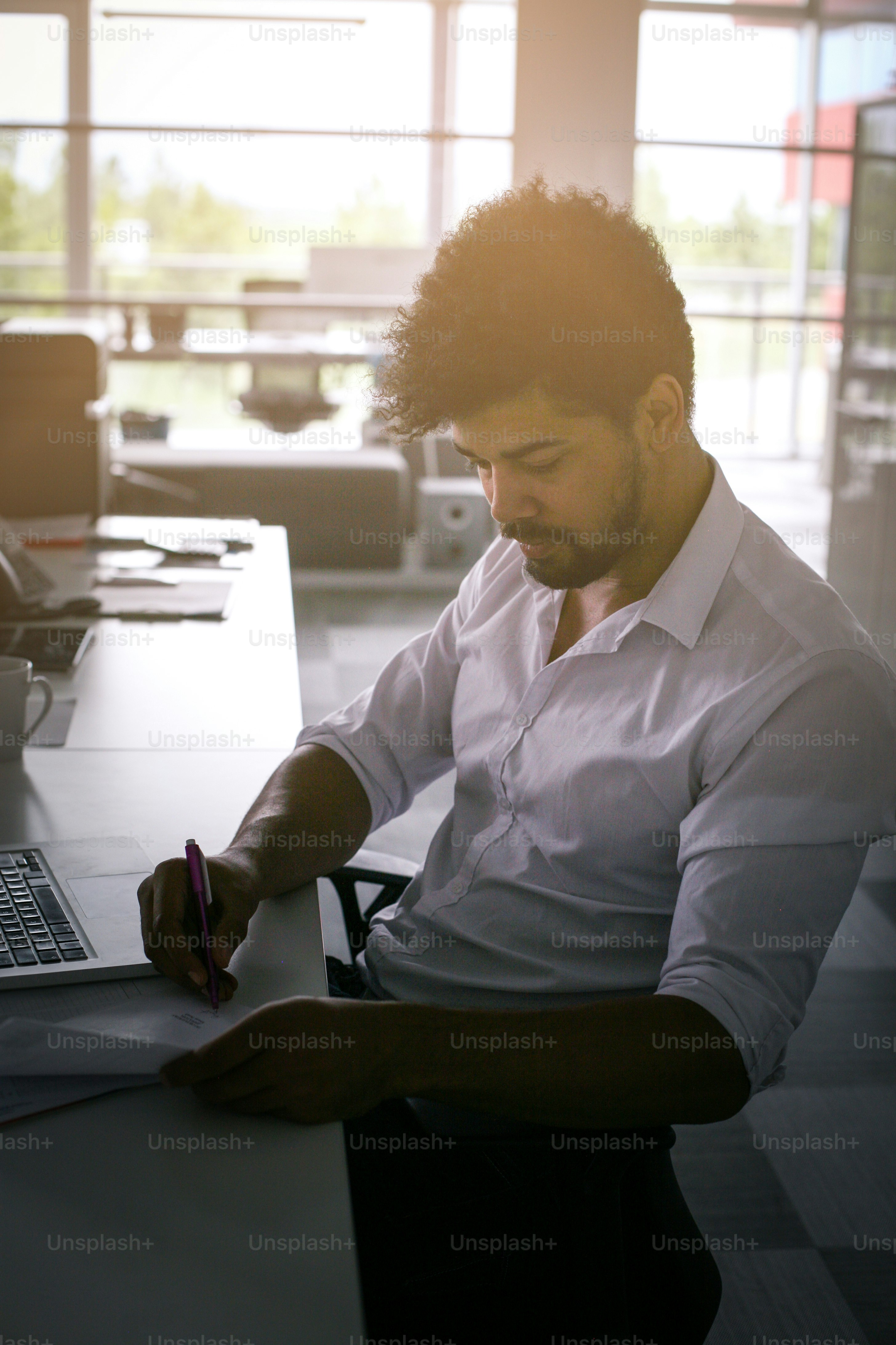 African business man writing document. African man working in office ...