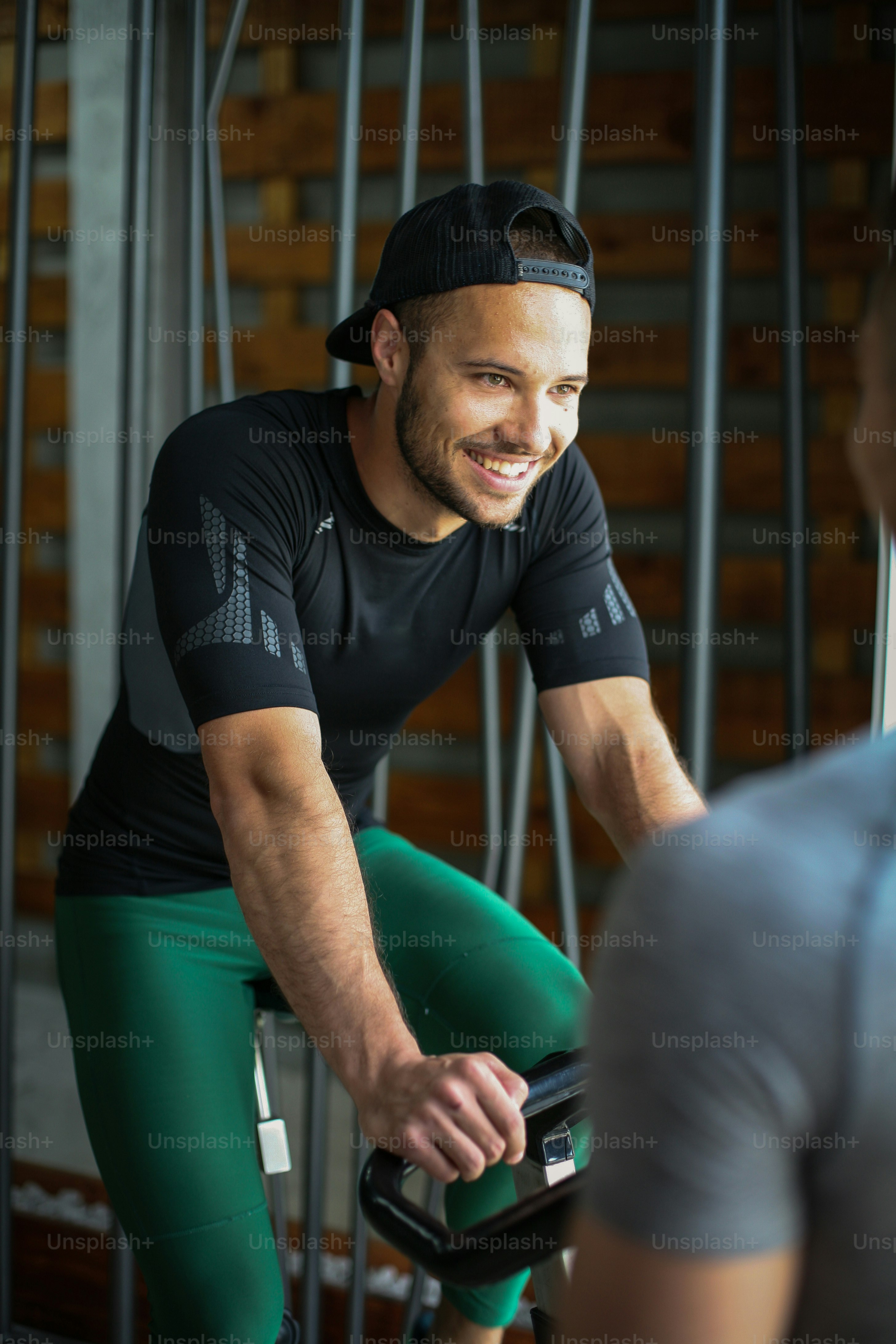 Young man exercise on stationary bikes in fitness class. Man workout in ...