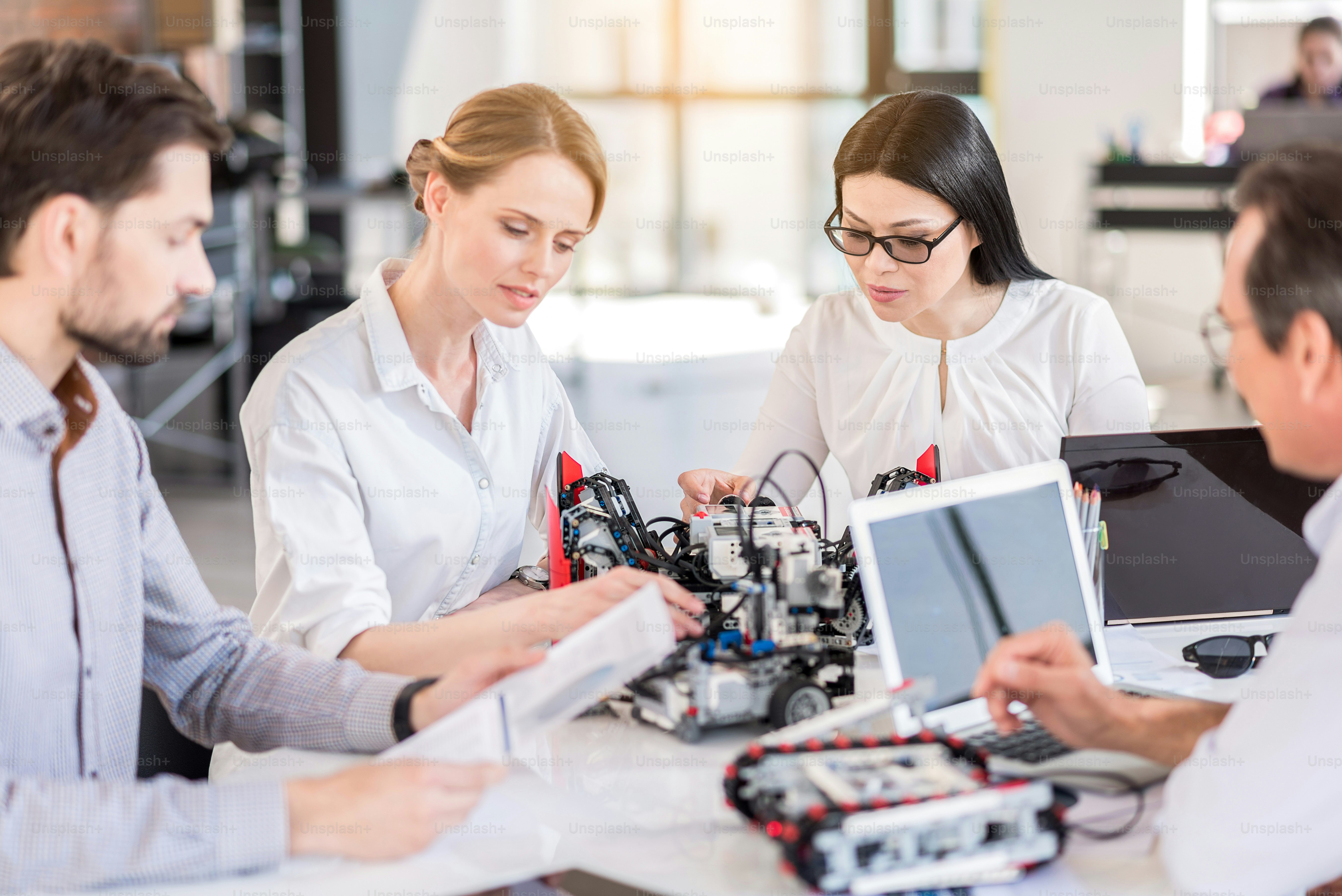 Time for new technologies. Group of inventors are working in office ...