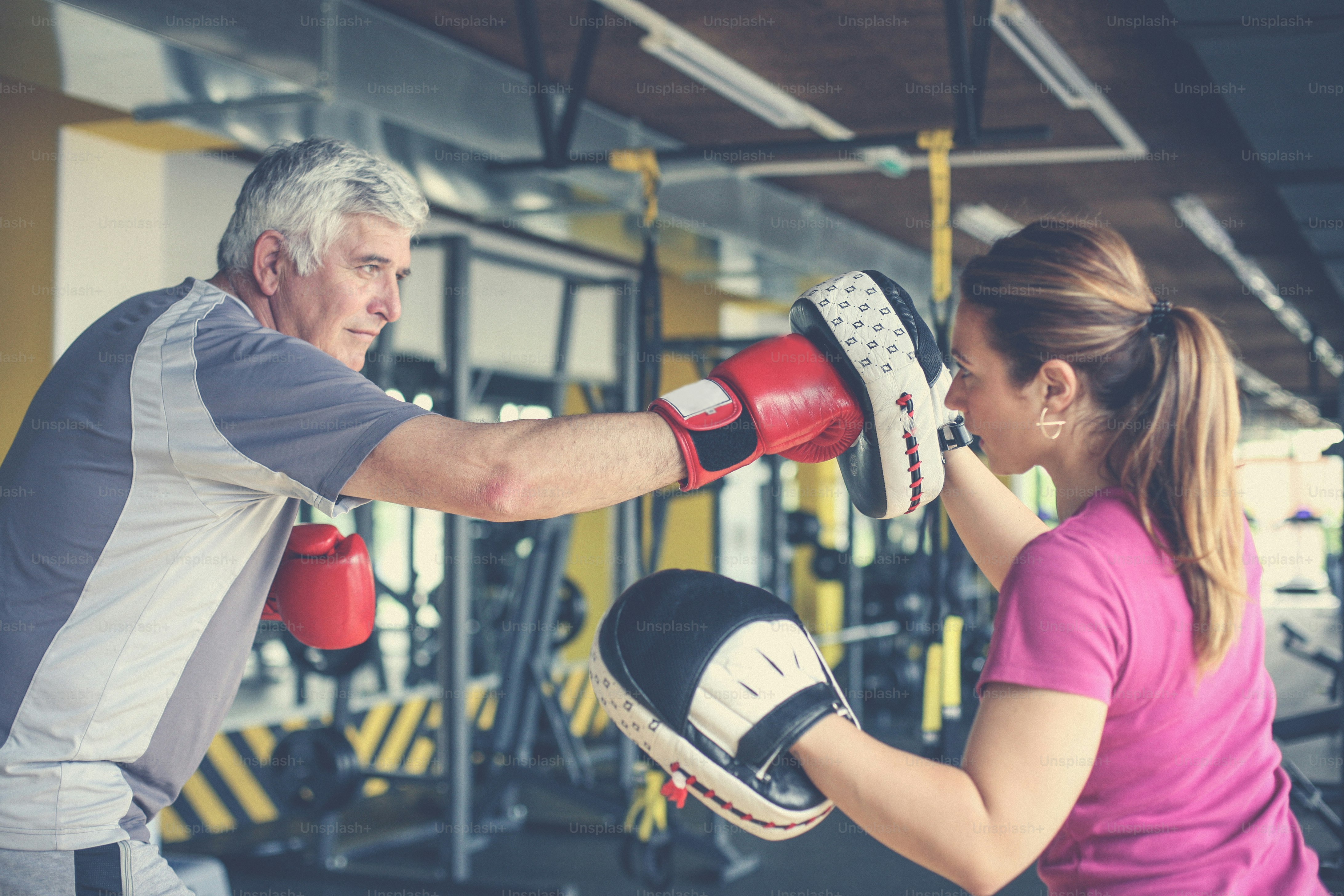 Older man boxing in gym. Senior man with personal trainer. photo – Old ...