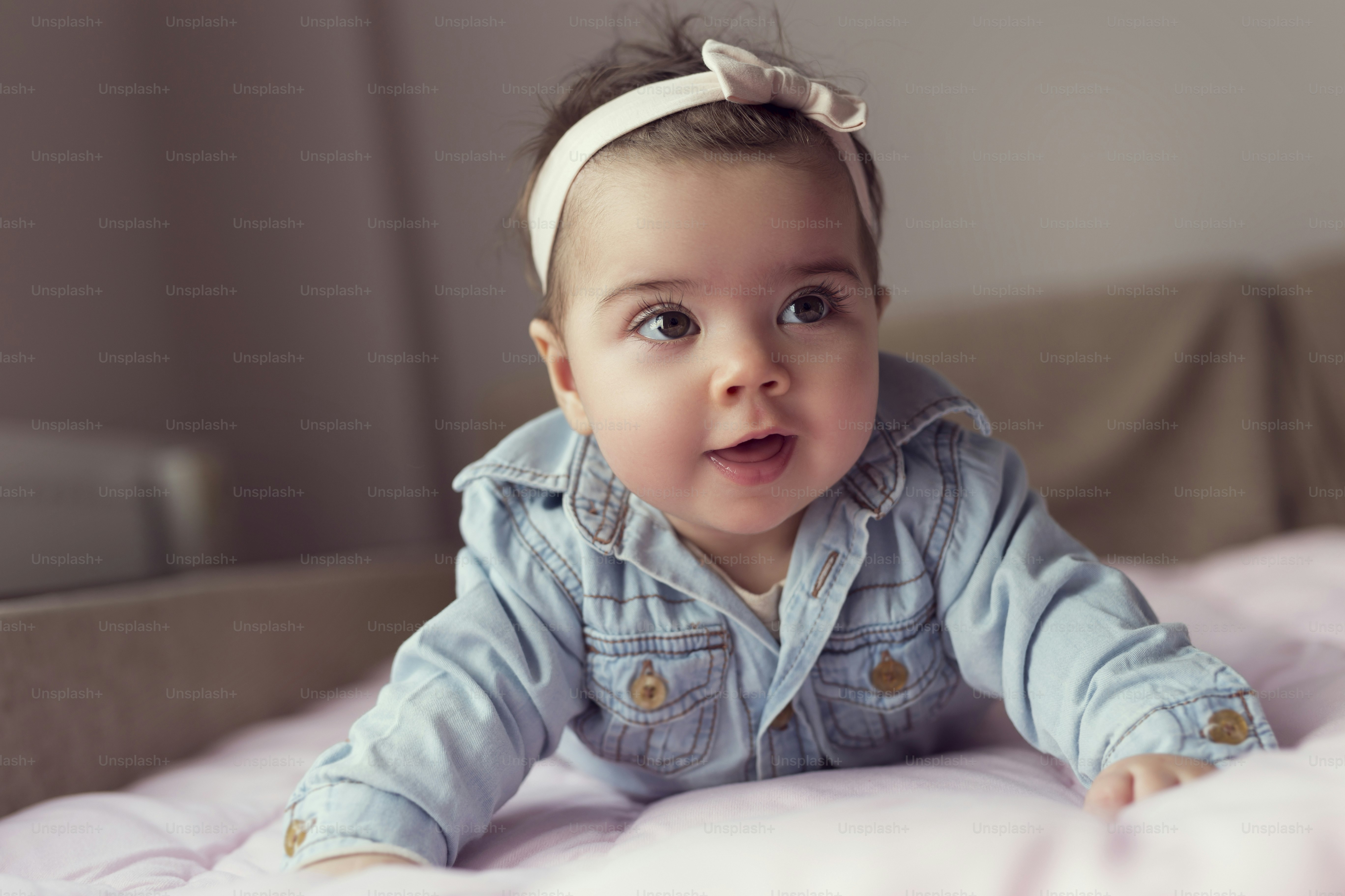 Beautiful baby girl crawling and rolling over in bed photo – People ...
