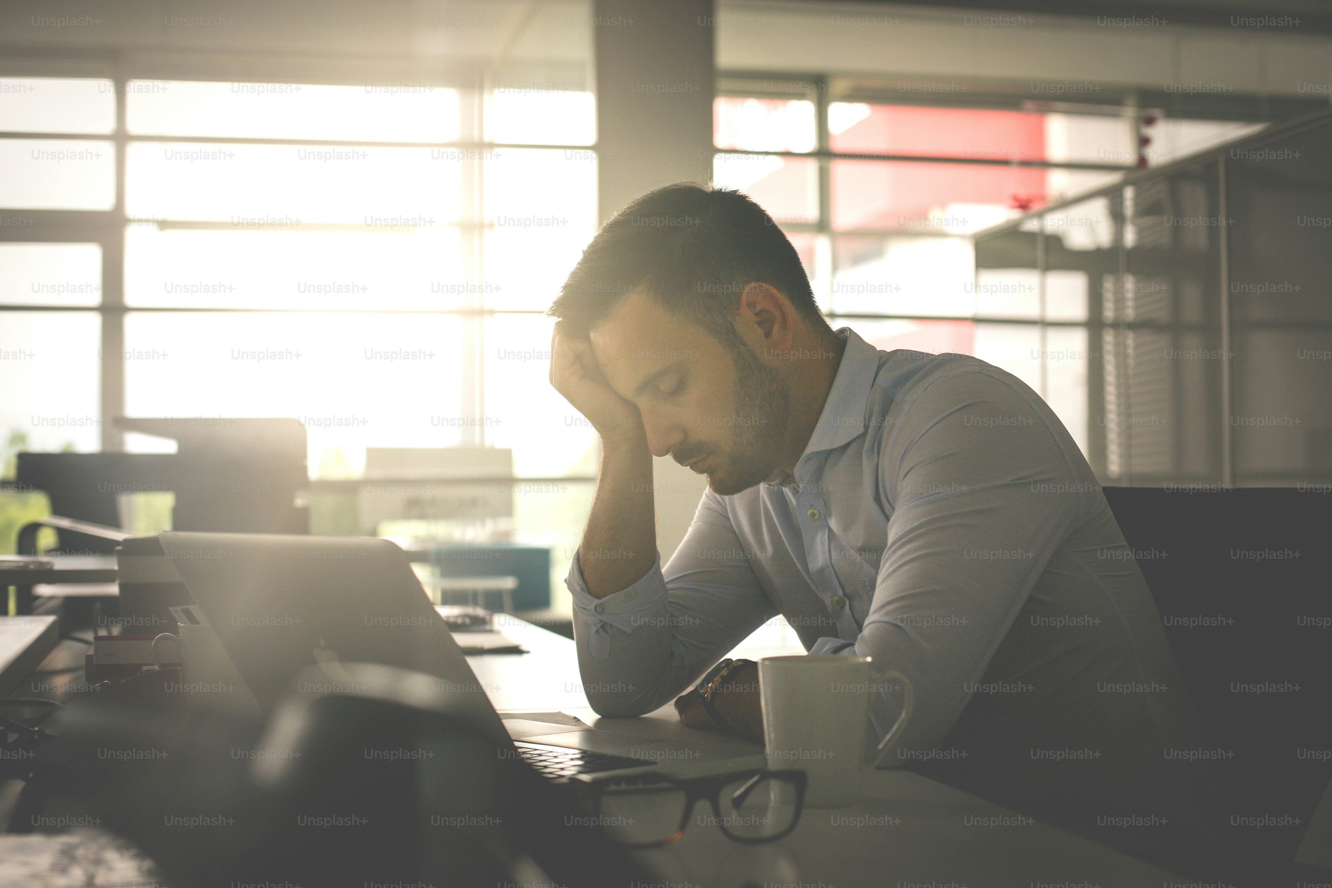 Business man having problem in the work. Business man sitting in office ...