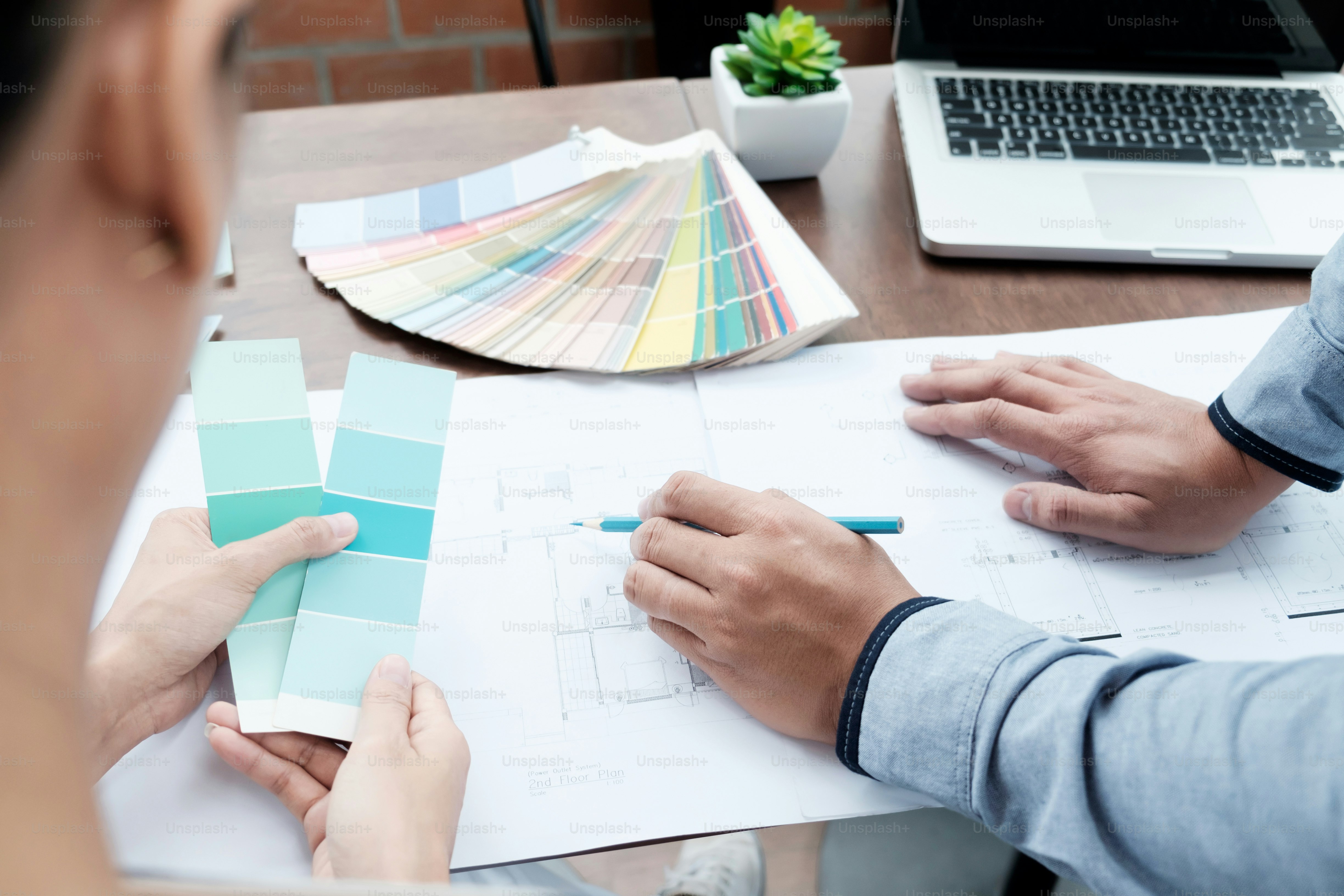 Graphic design and color swatches and pens on a desk. Architectural ...