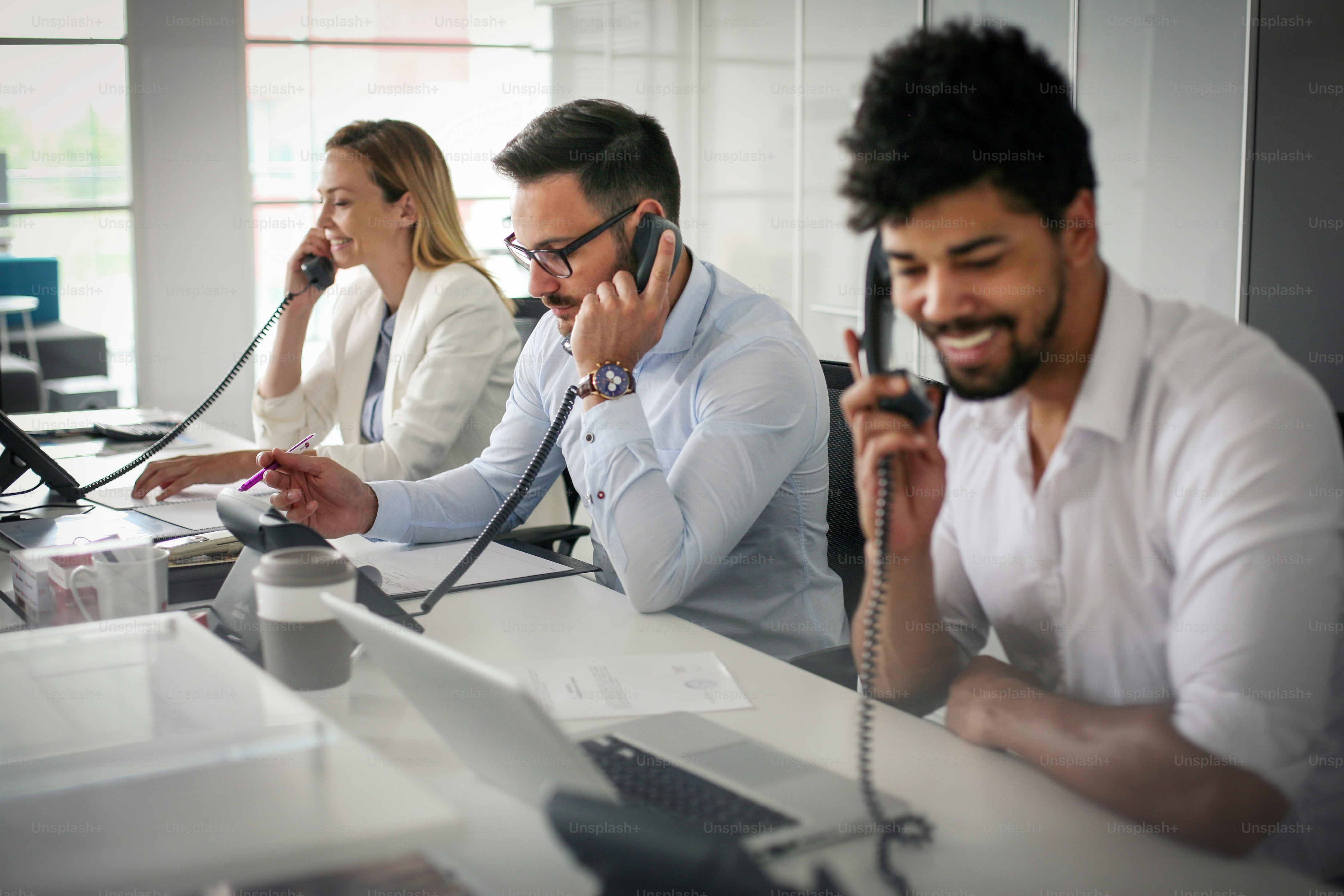 People in operations center talking on Landline phone. Operators in the ...