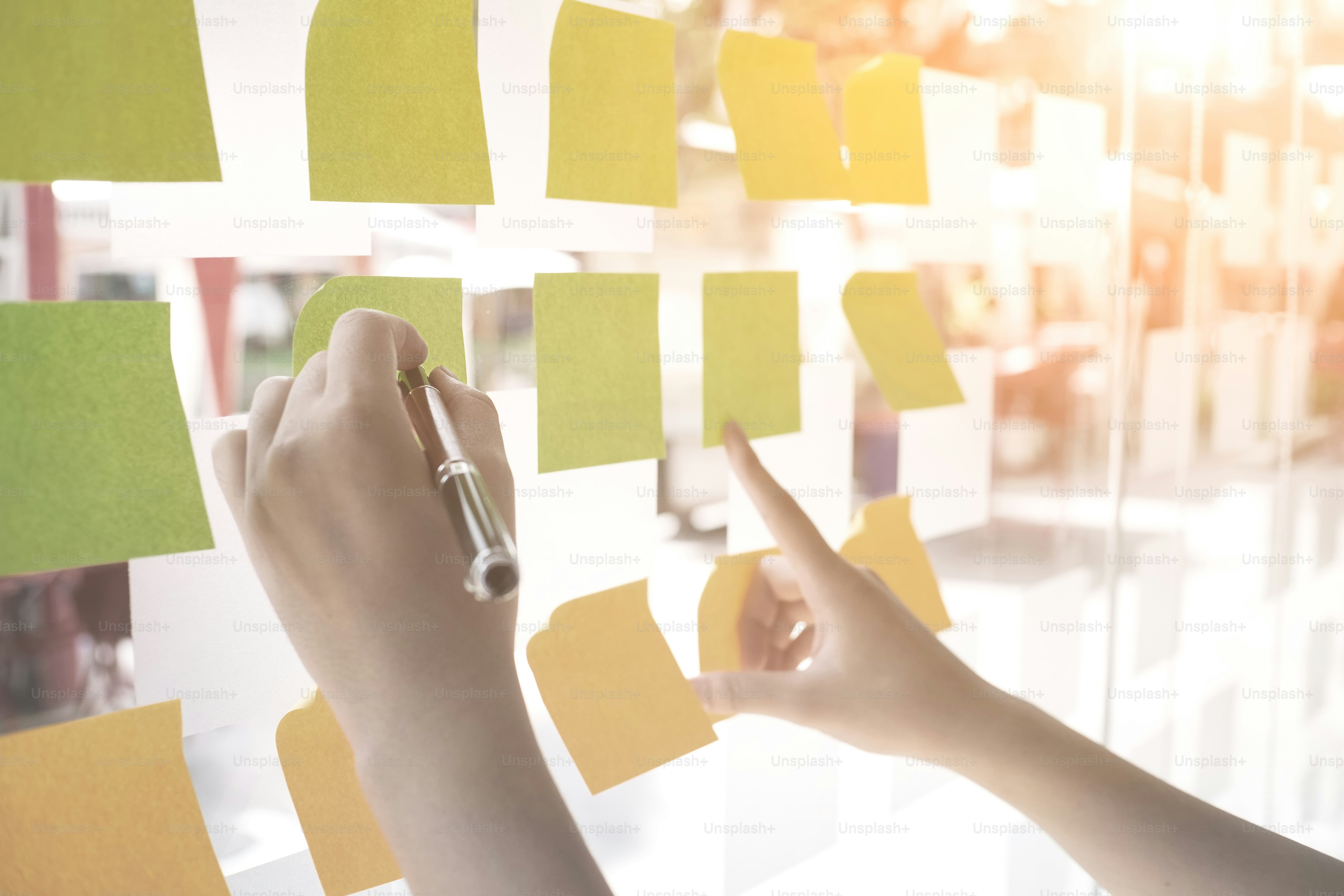 Hands using post it paper note to memo or share ideas. photo – Post its ...