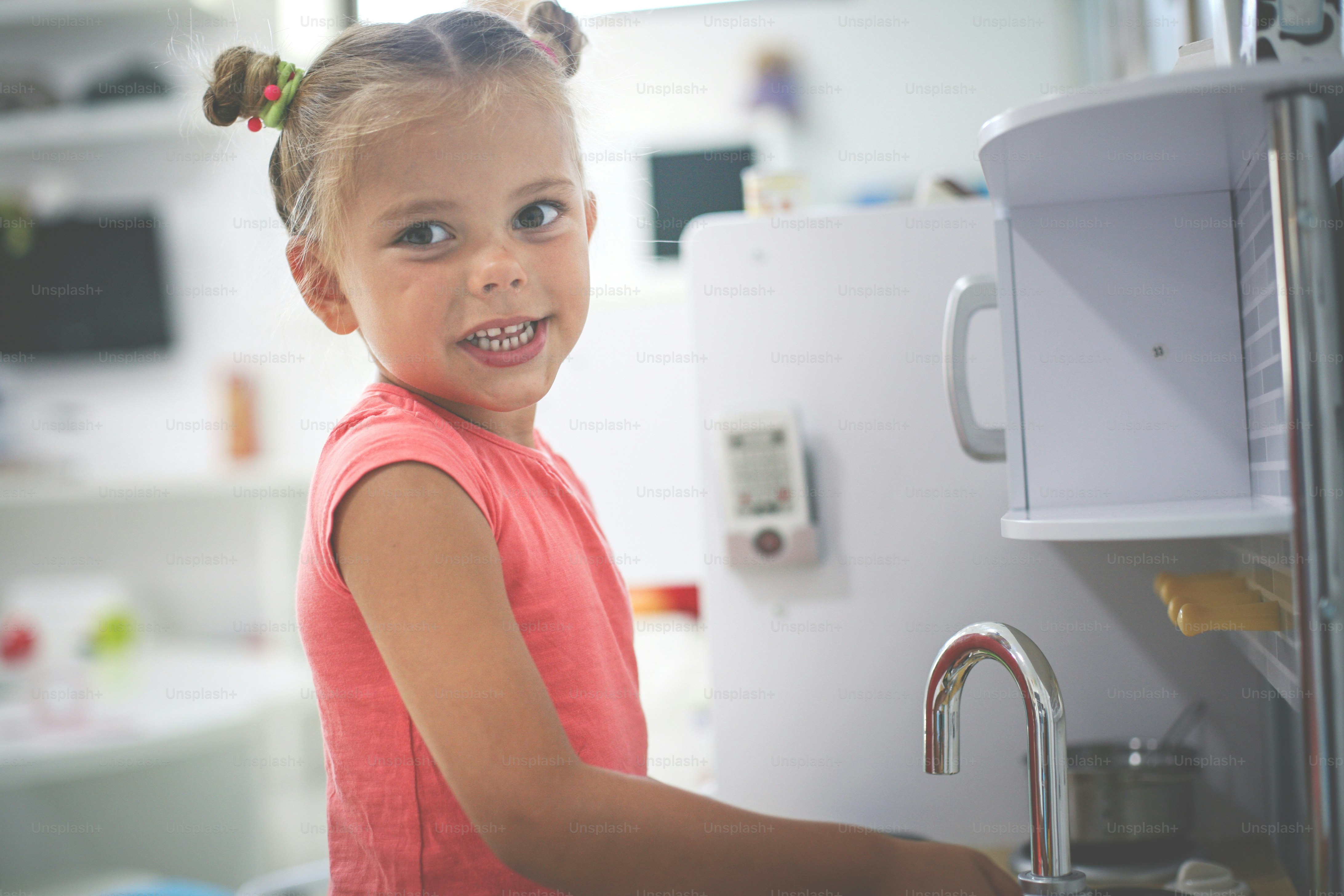 Little girl in playground. Girl playing in children kitchen. photo ...
