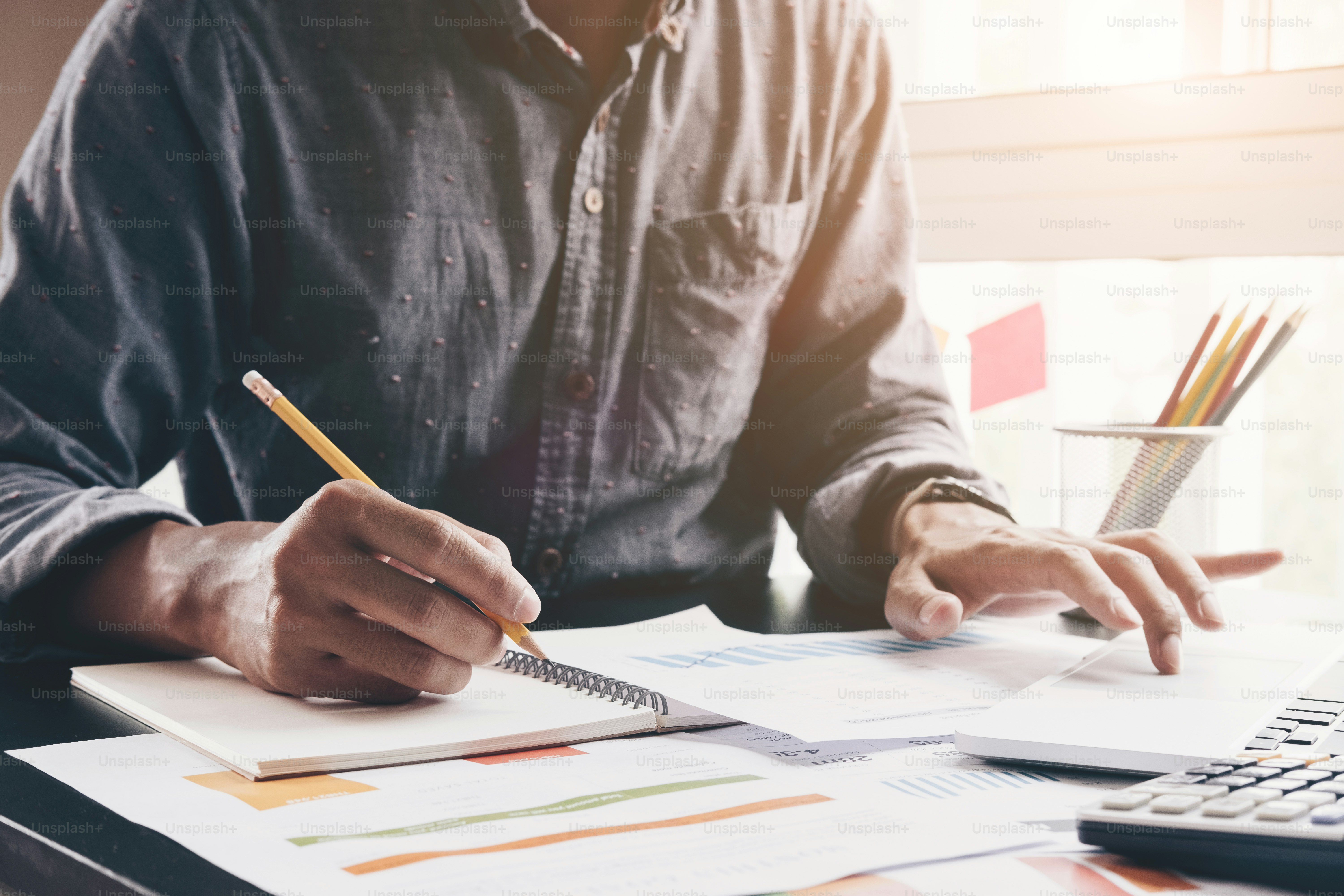 Close up accountant man using laptop computer and calculator while ...
