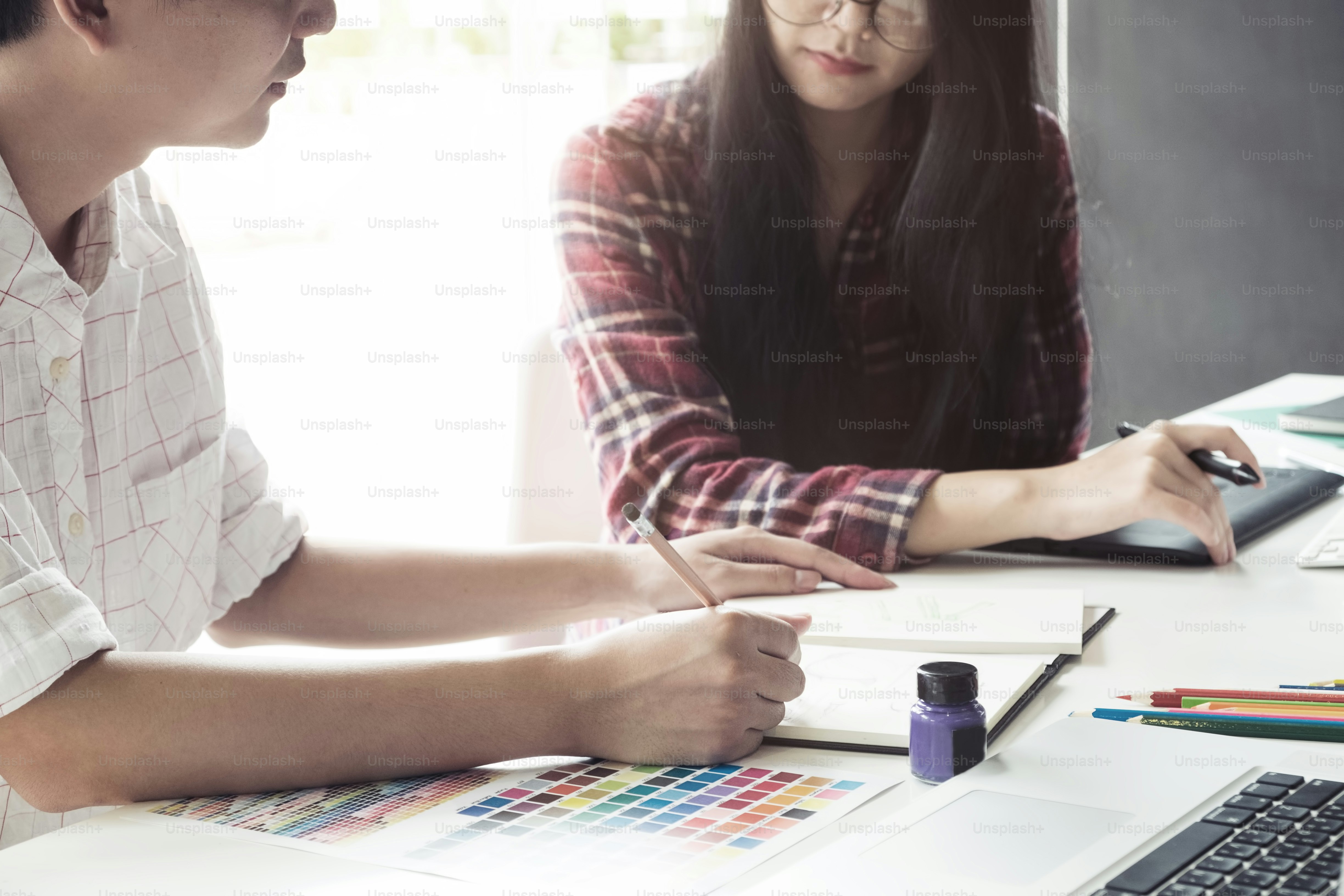 Artist creative graphic designer team talking to art work plan working ...