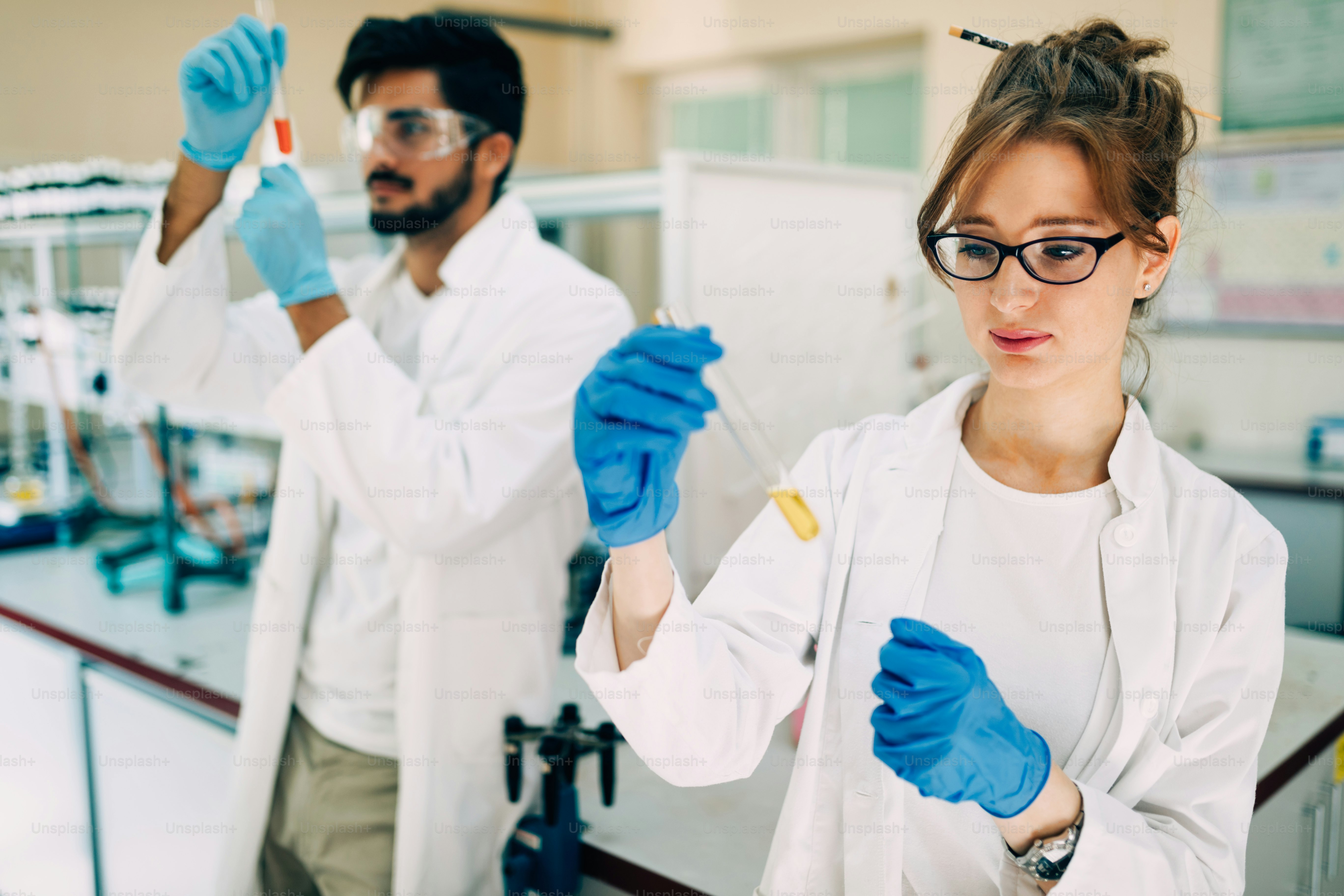 Young students of chemistry working together in laboratory photo ...