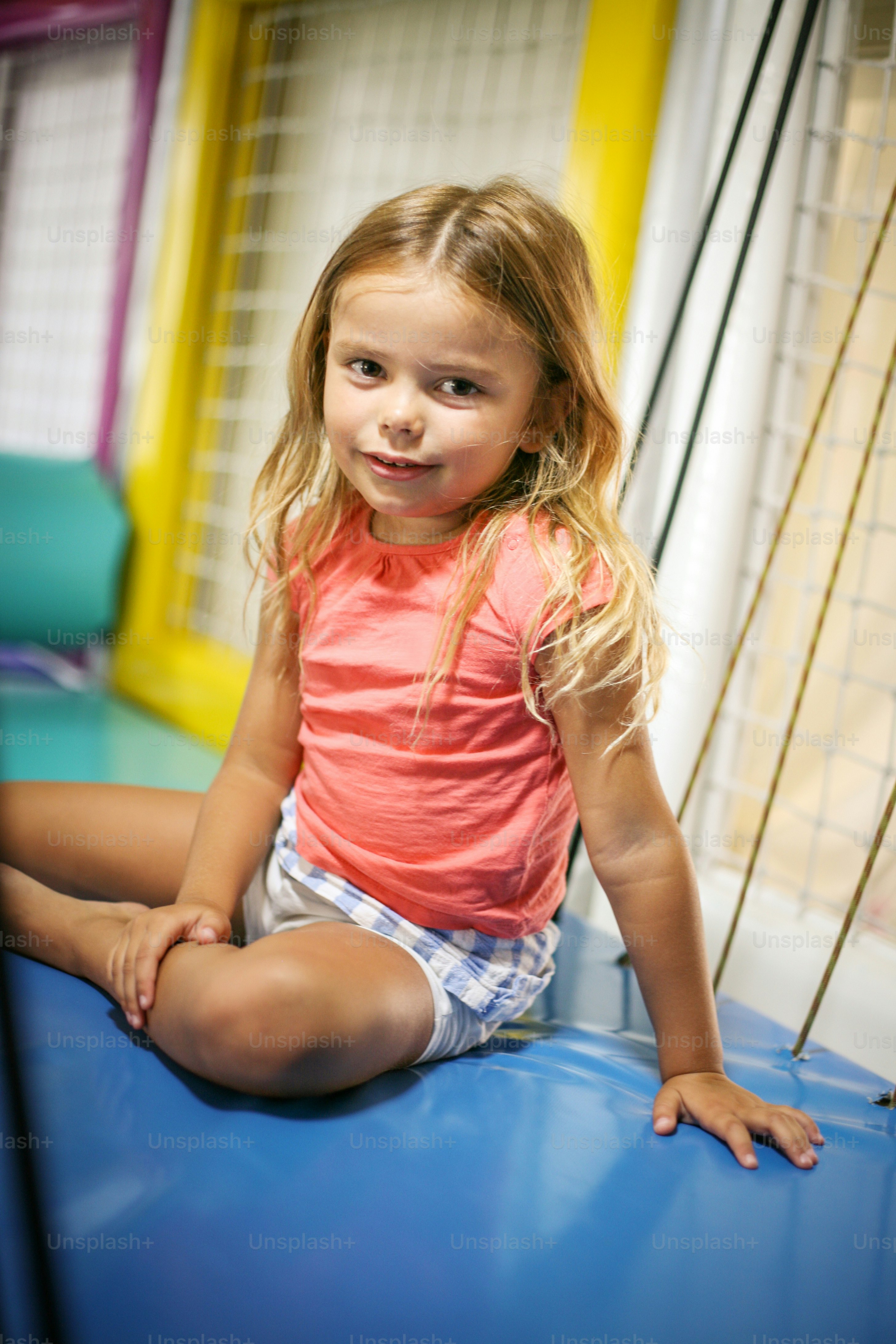 Little girl in playground. Caucasian girl looking at camera. photo ...