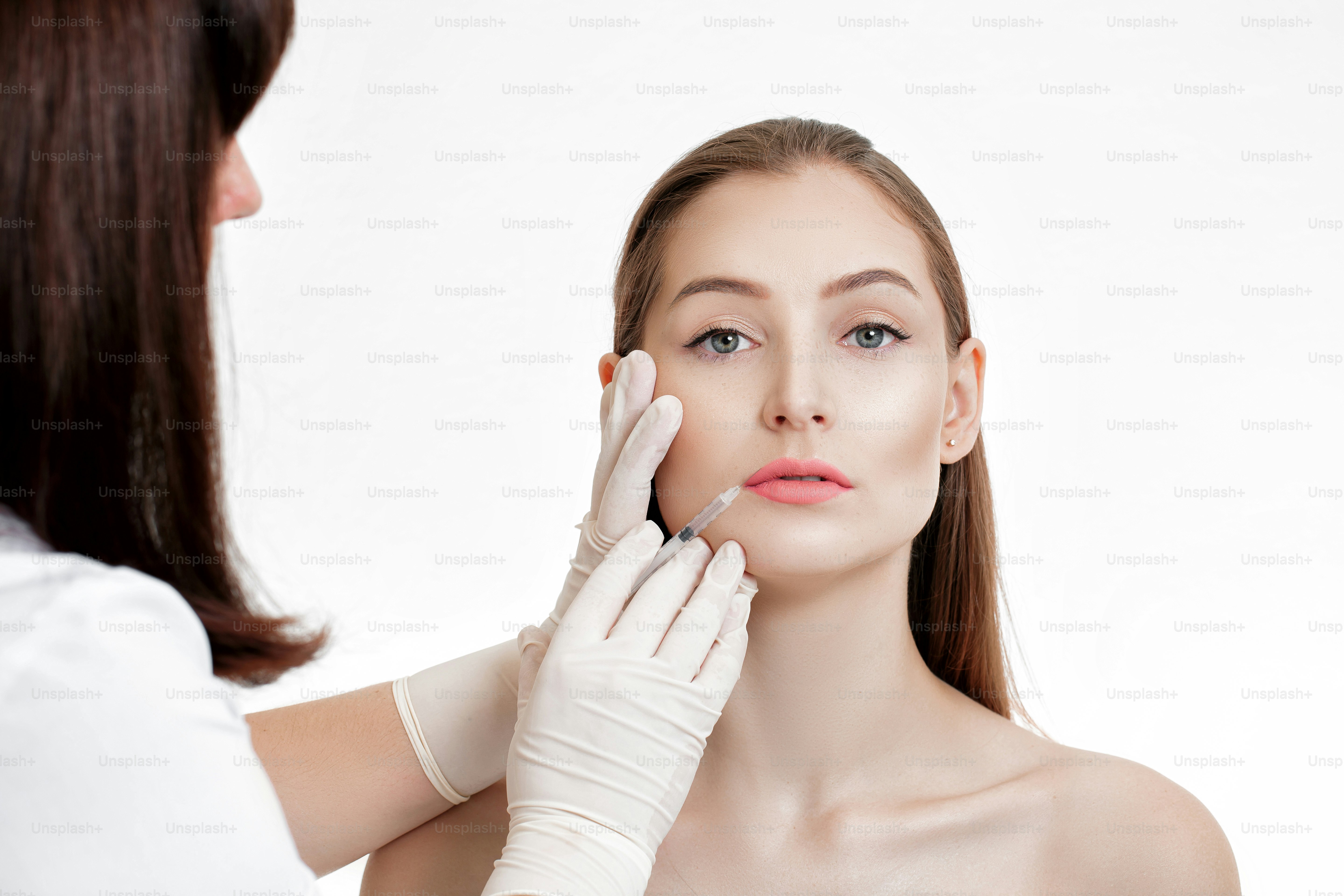 Portrait of beautiful woman getting injection on lips. beauty ...