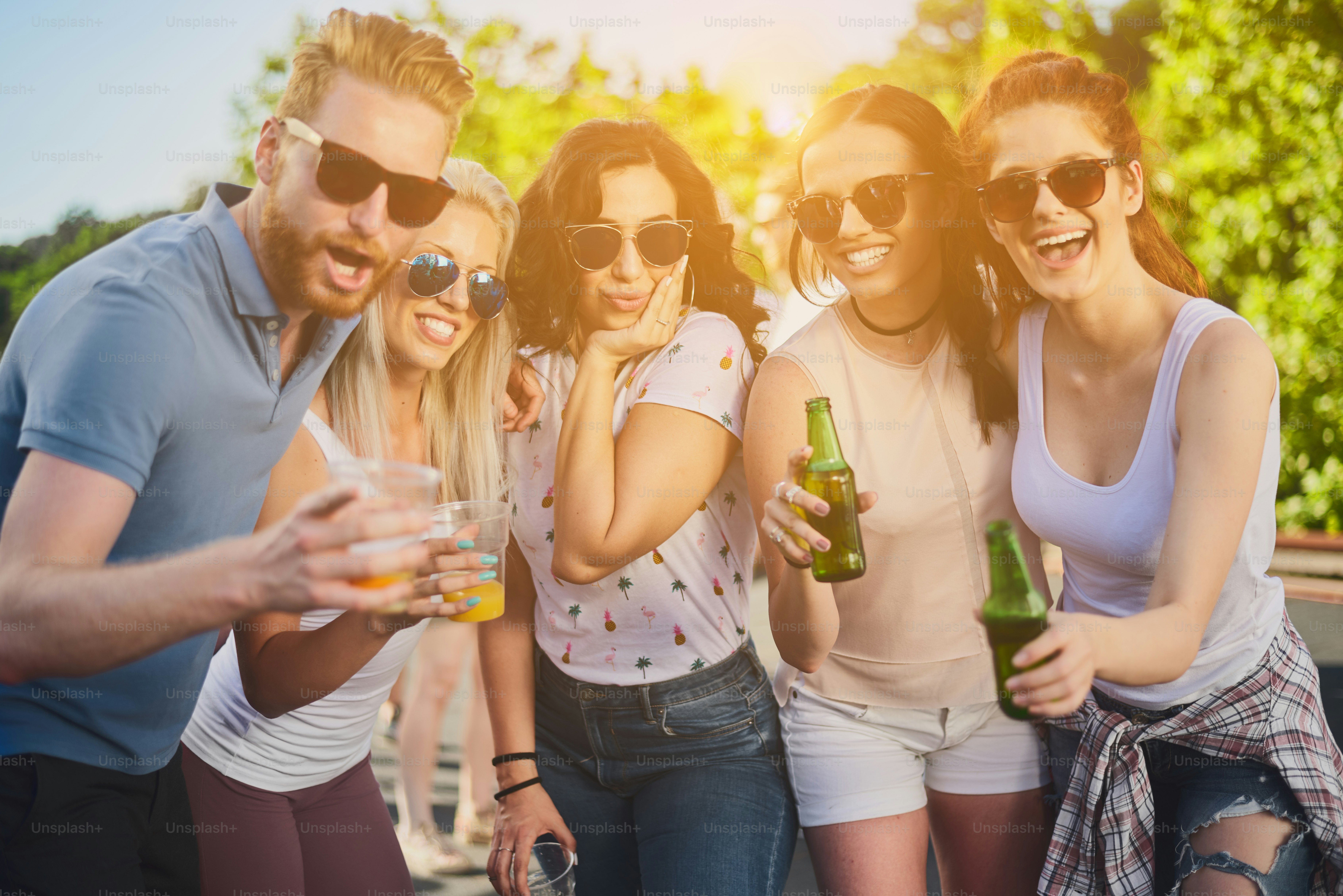Small group of friends posing at the summer outdoor party photo ...