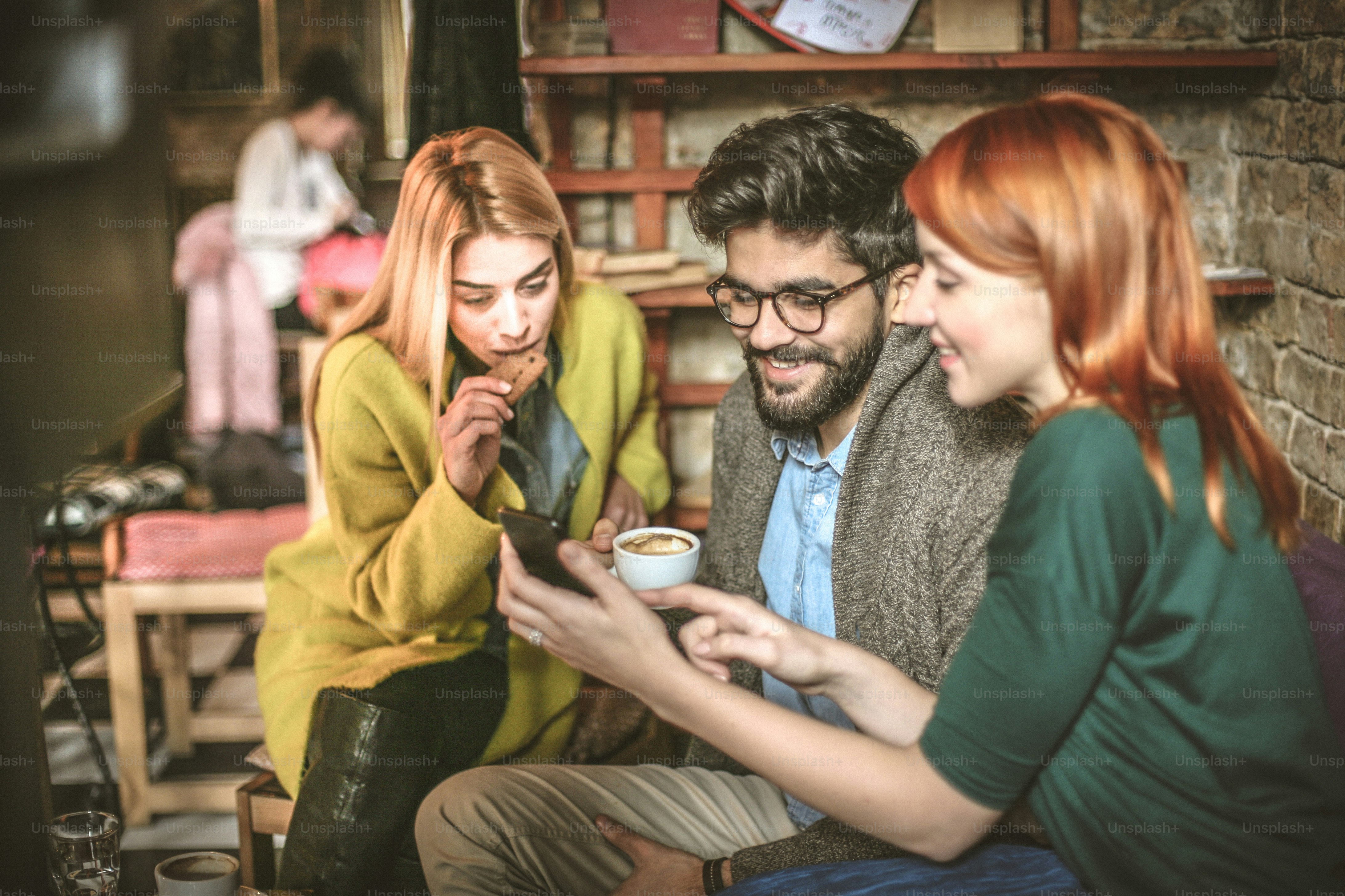Three young students at coffee break have discussion. photo – Cafe ...