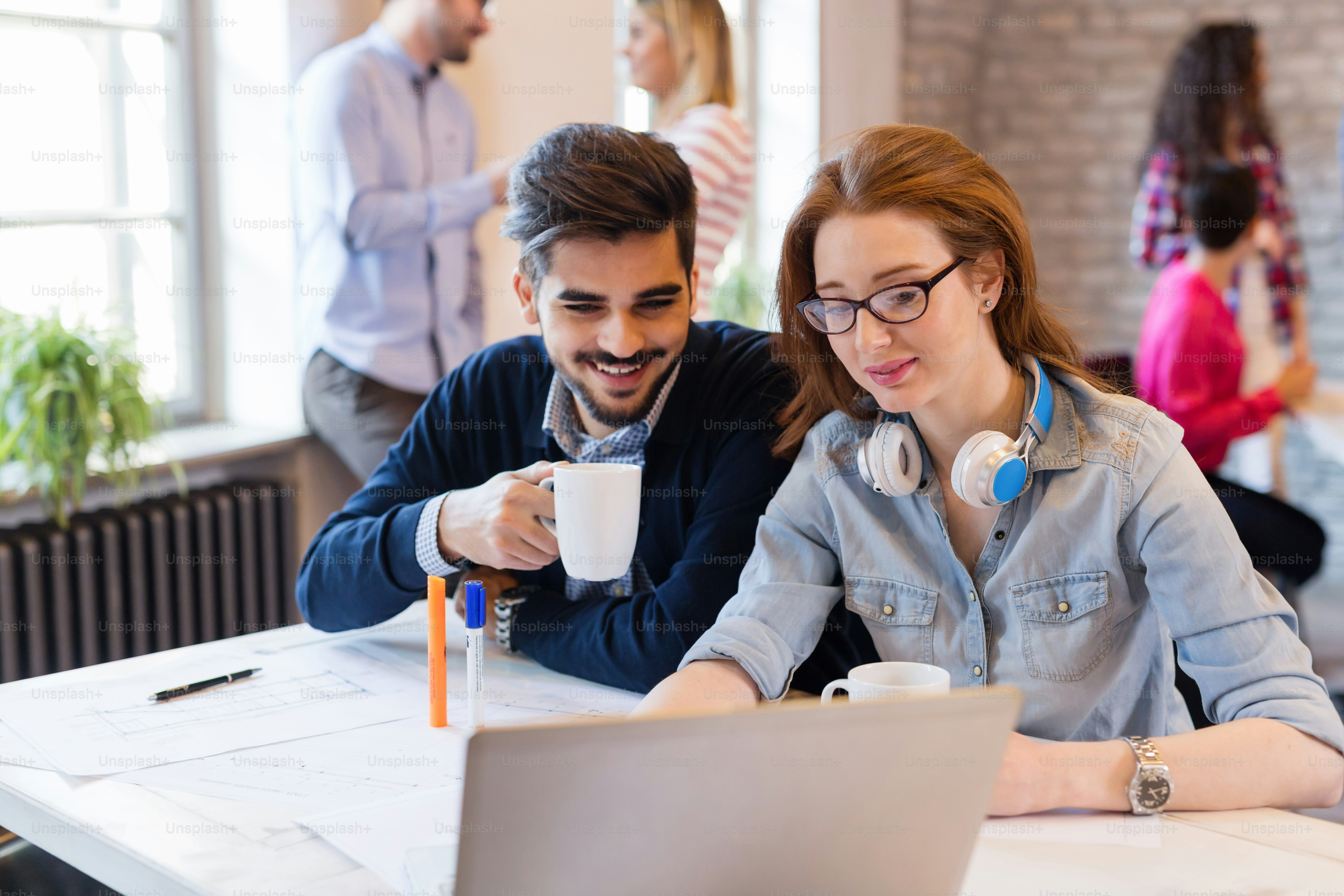 Coworking colleagues having conversation at workplace and sharing ideas ...