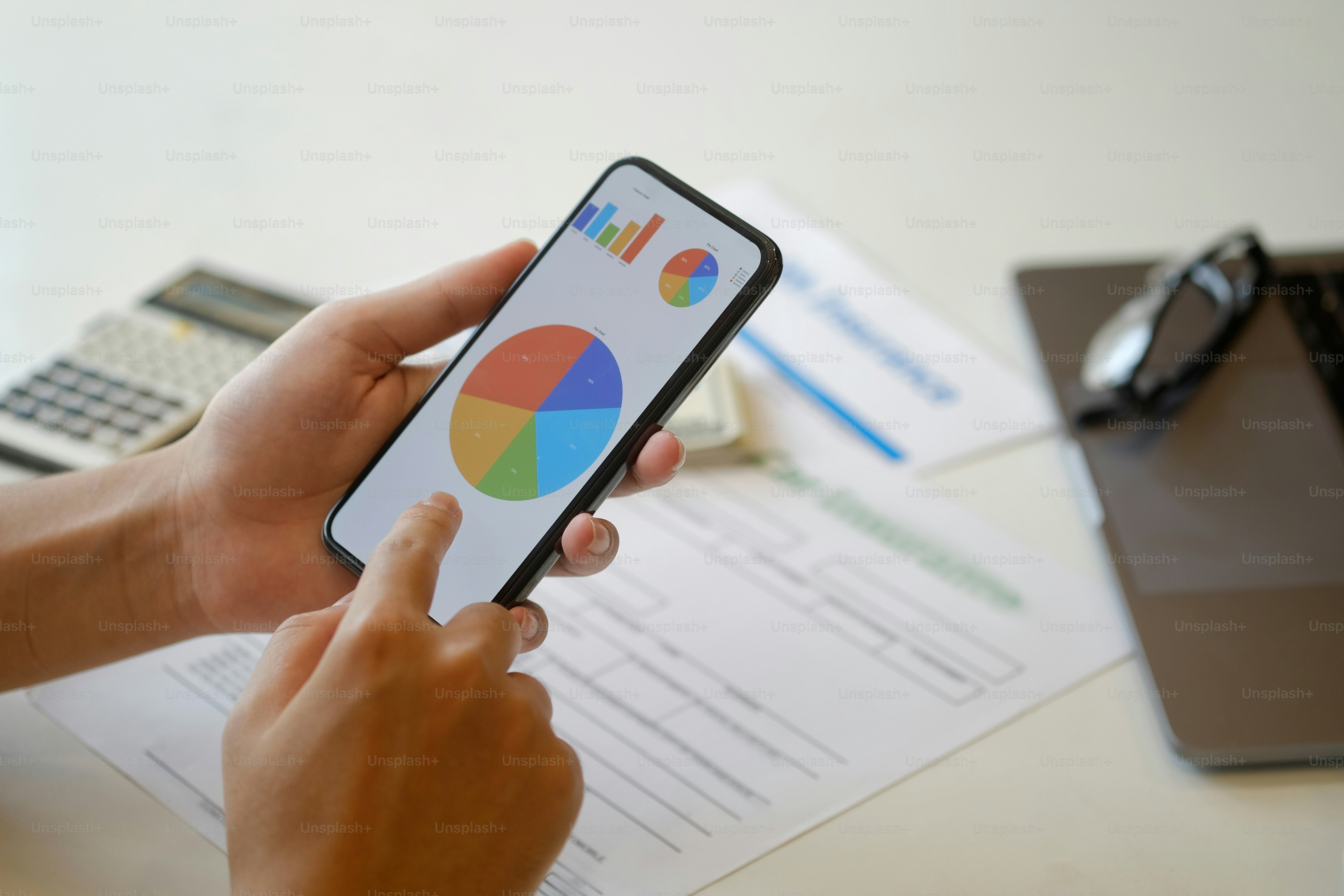 Businessman's hands shows mobile smartphone with analysis data on ...
