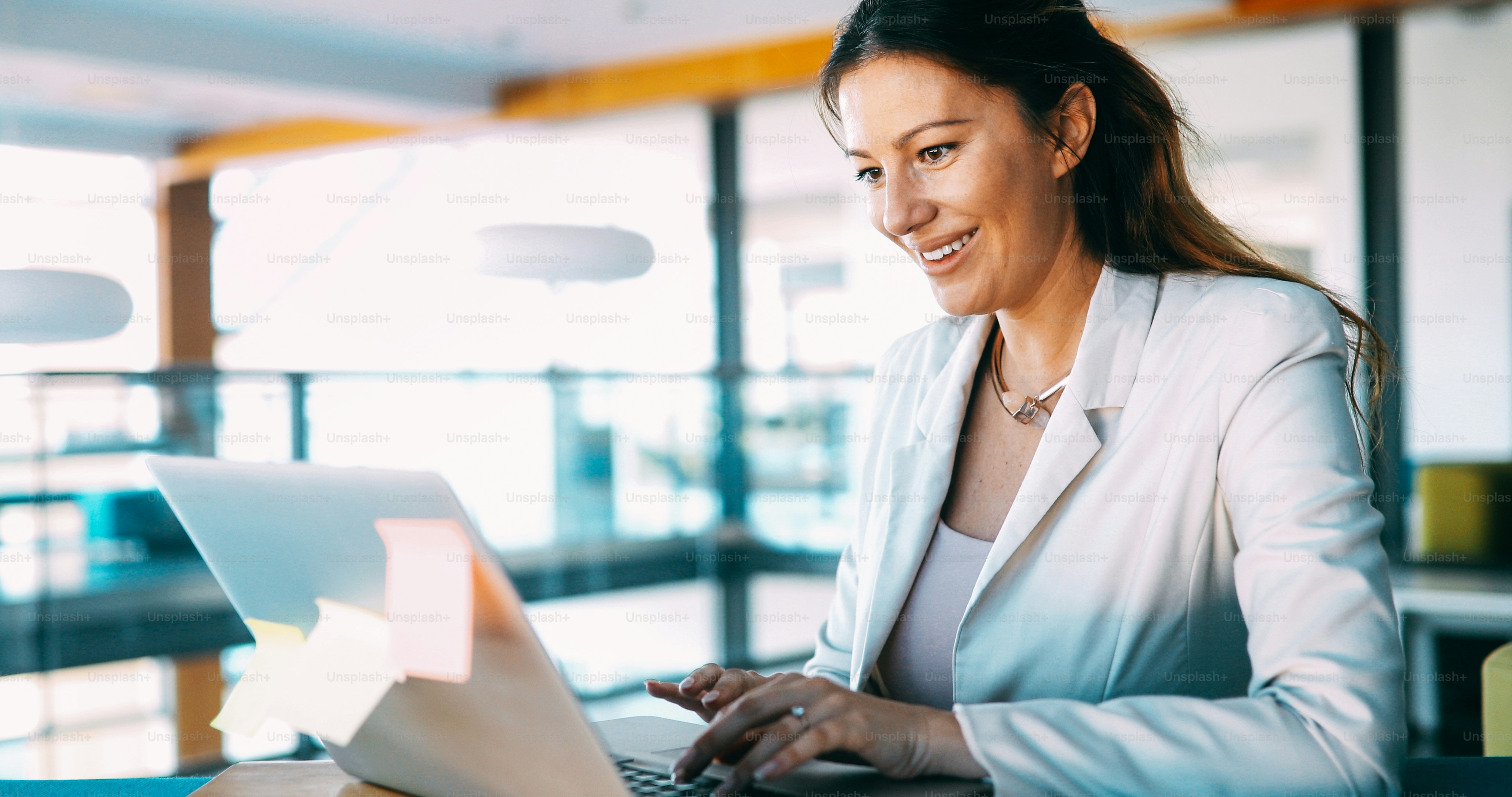 Young beautiful employee working on computer during working day in ...