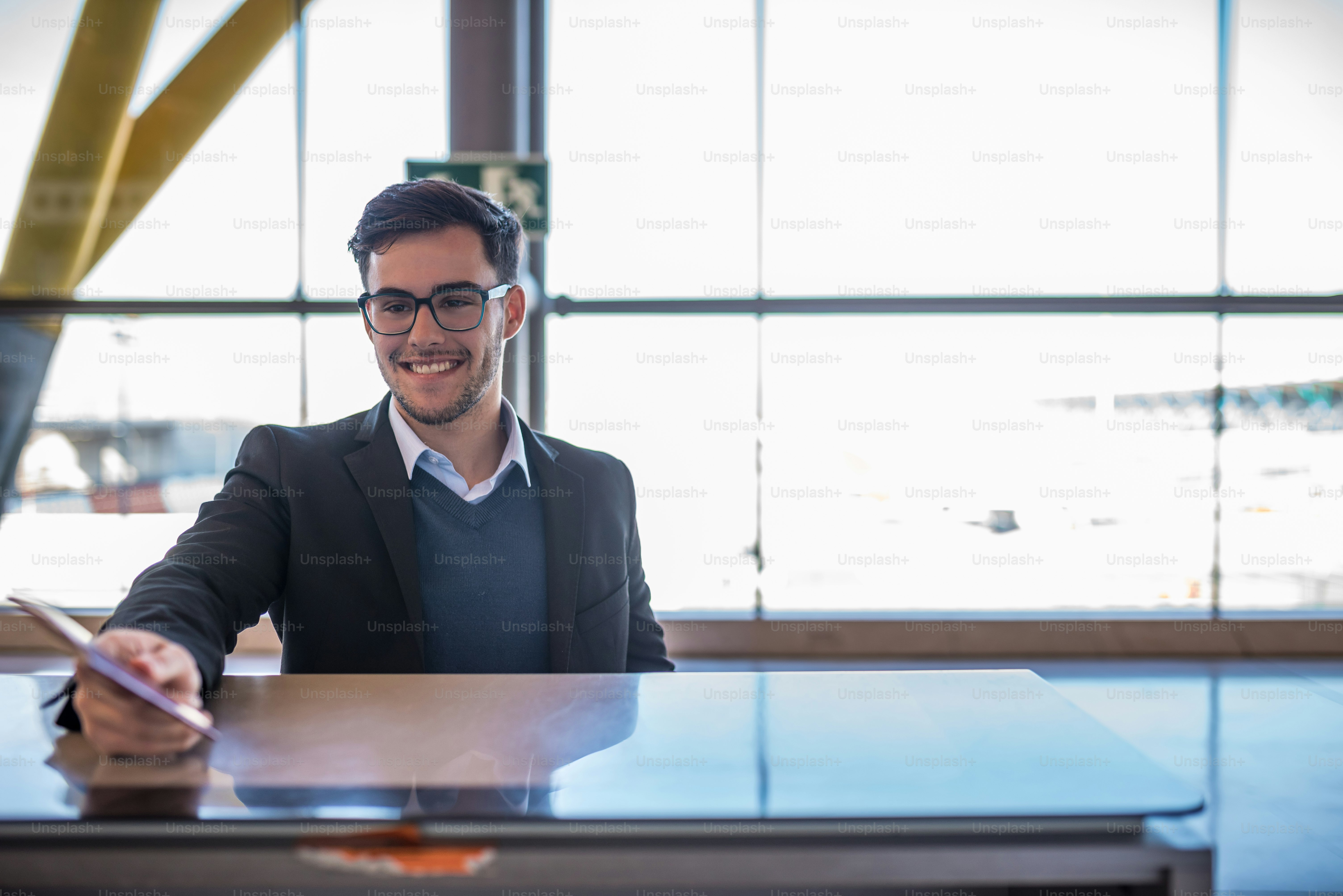 Attractive young man check-in at the airport with his passport photo ...