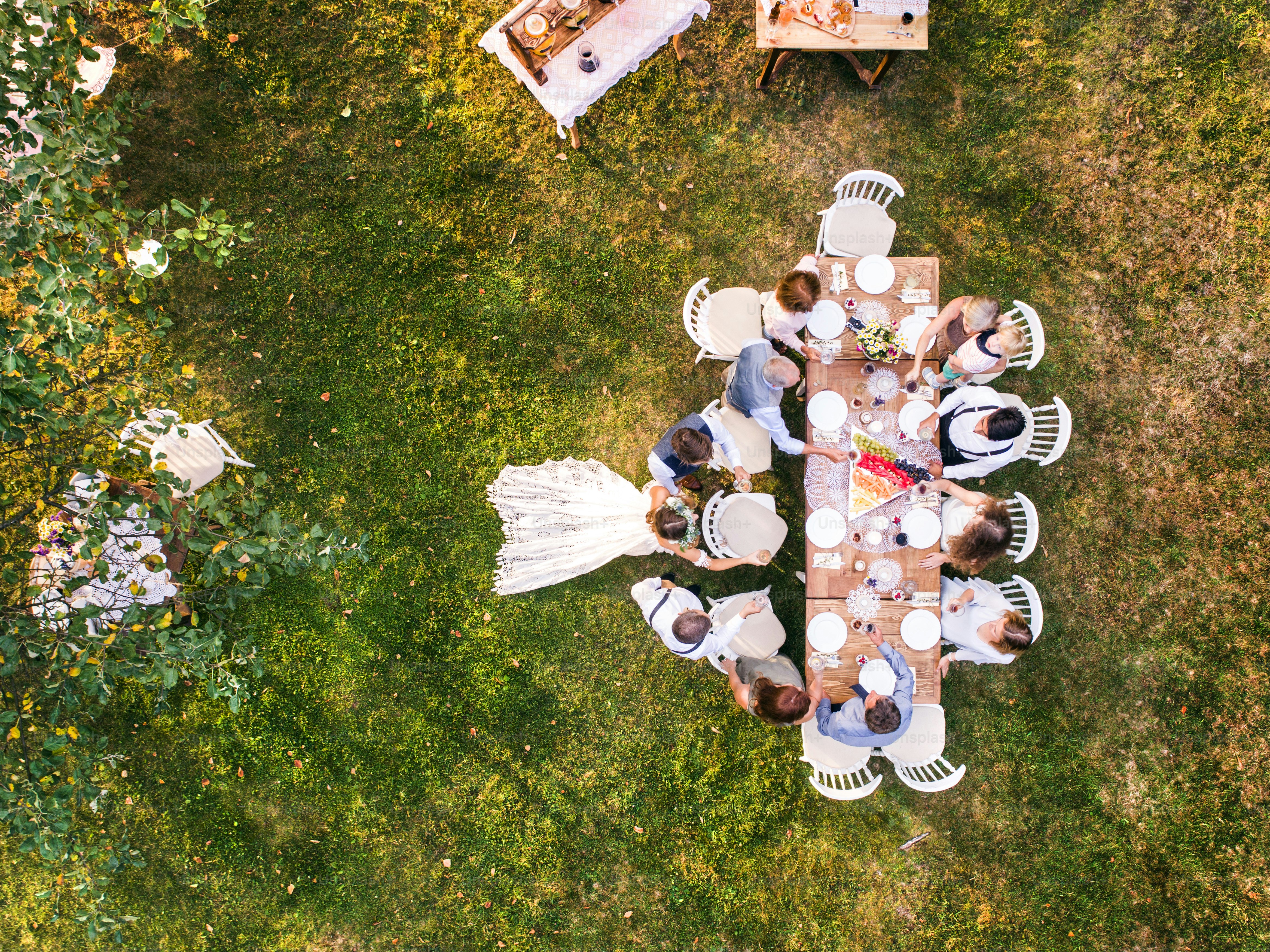 Wedding reception outside in the backyard. Bride and groom with a ...