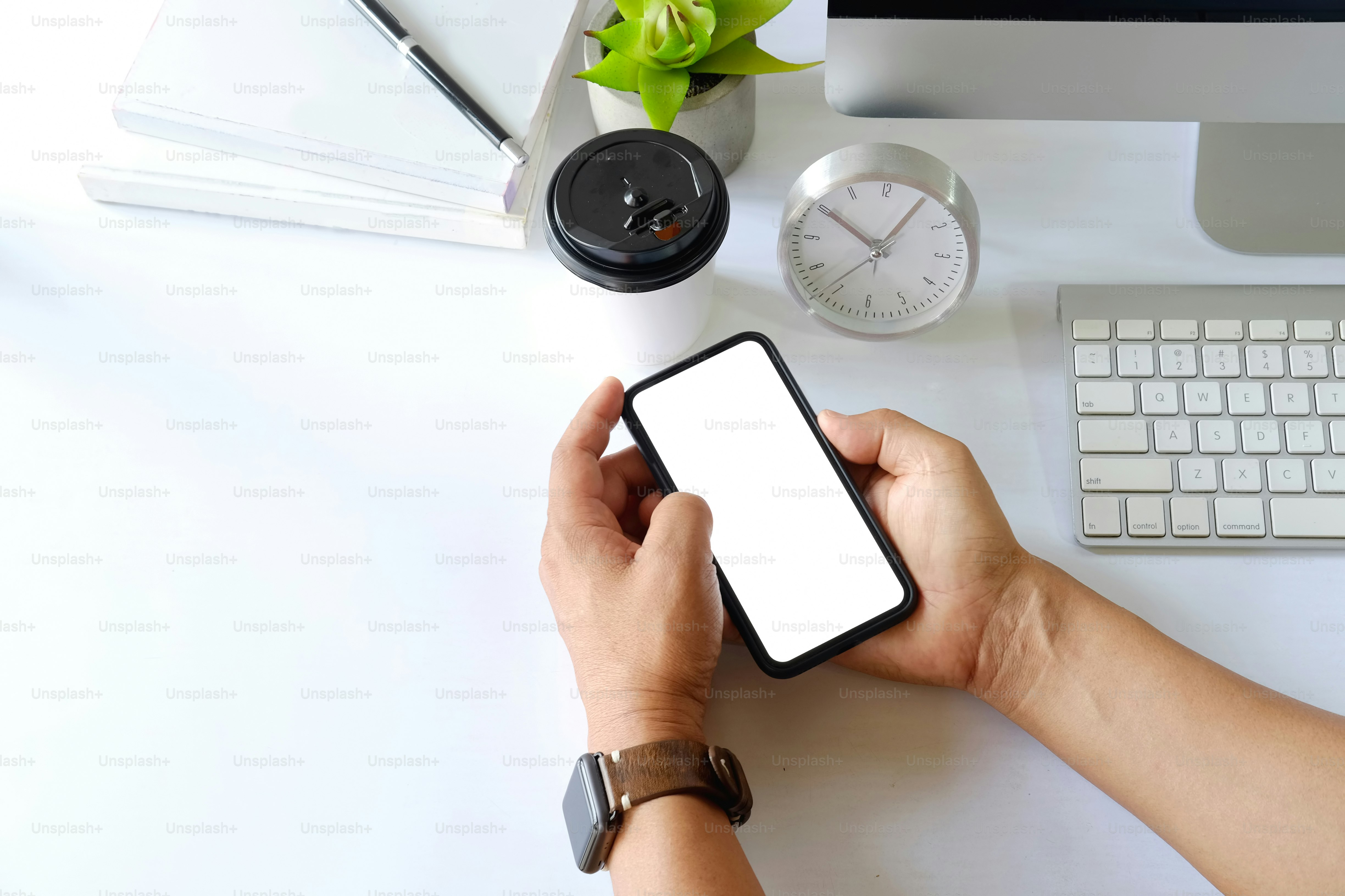 High angle shot of an unrecognizable businessman using a smart phone at ...