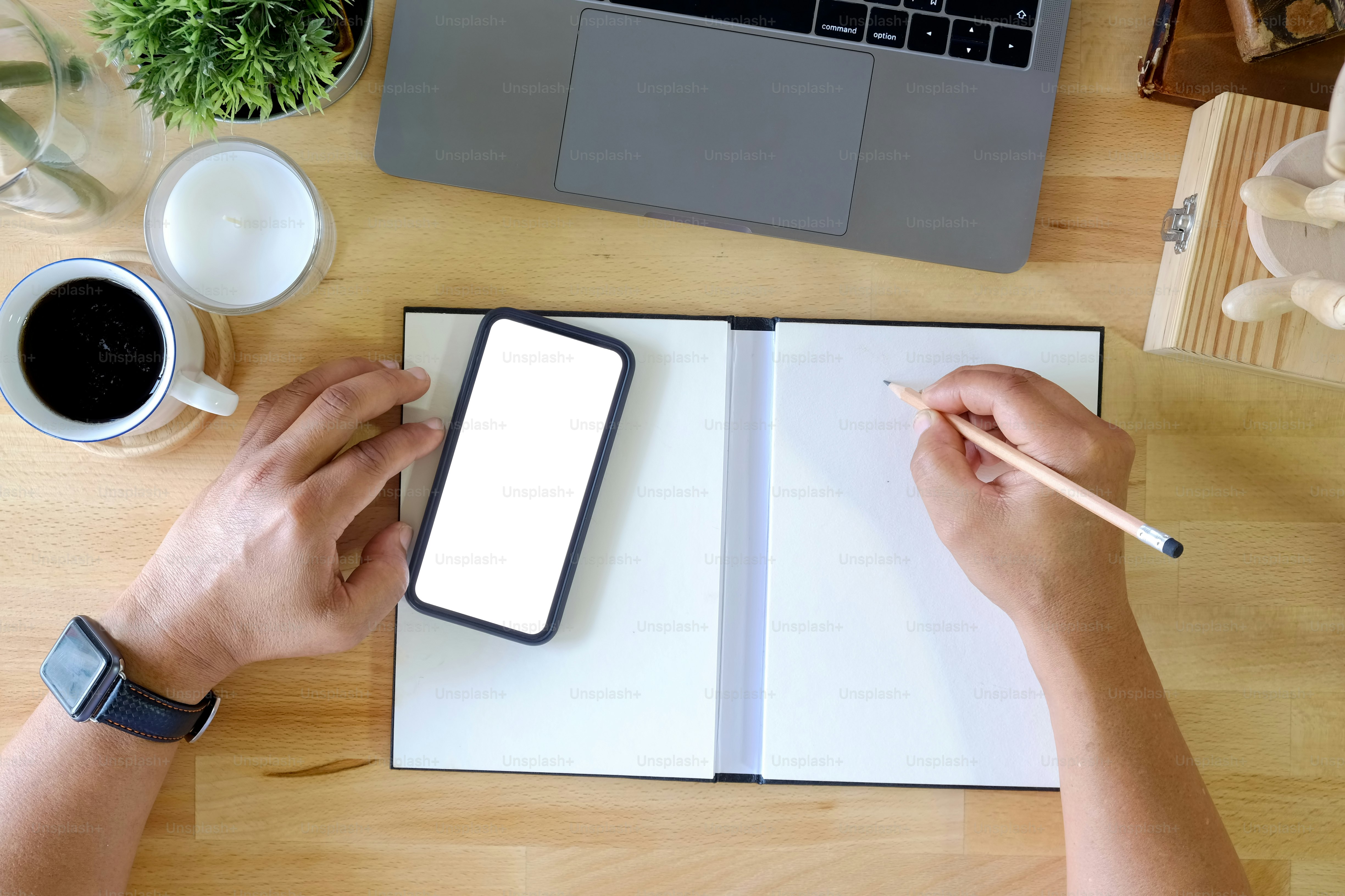 Man hand writing on white notebook on office desk with office accessory ...
