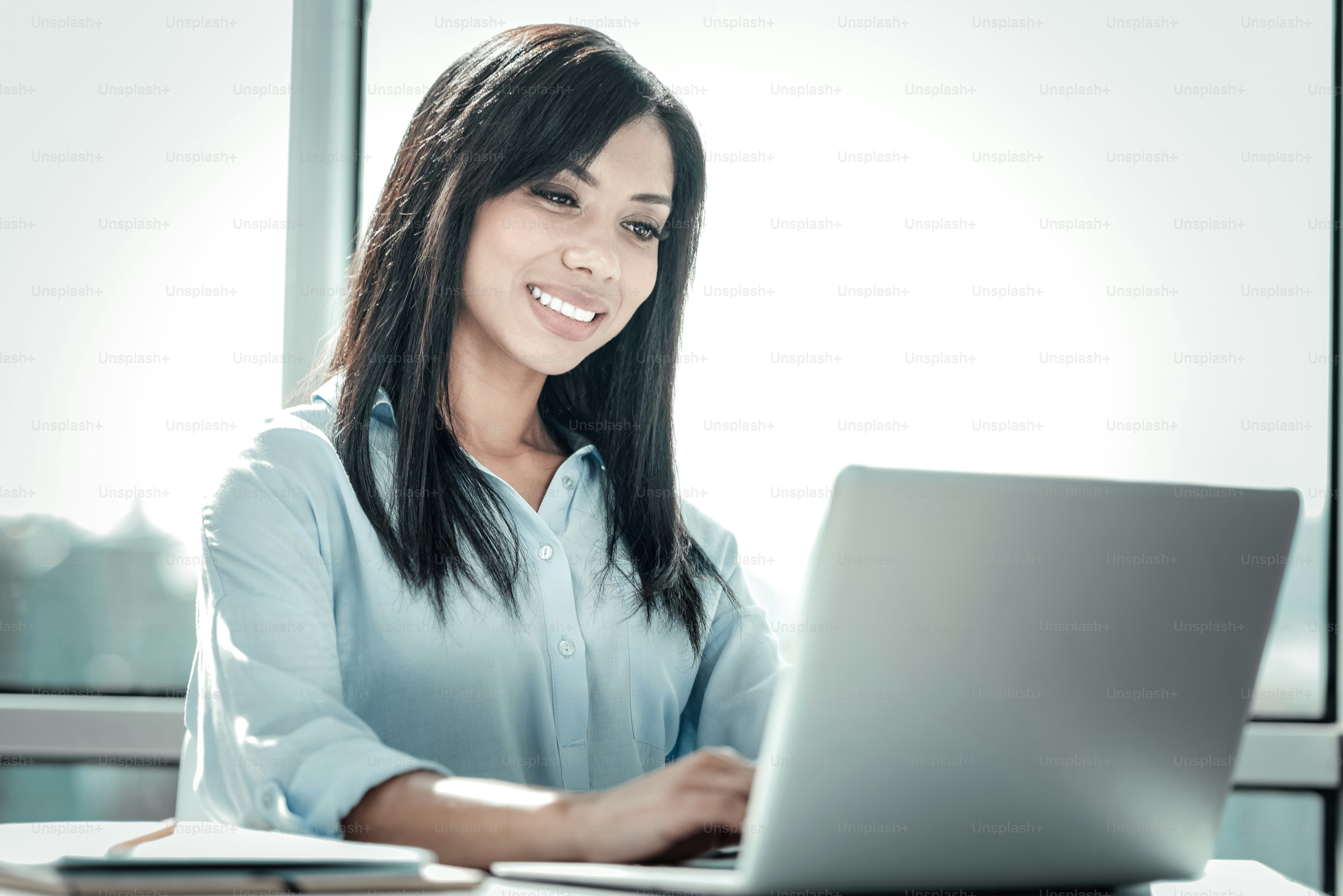 Best work. Pretty occupied responsible employee sitting by the table ...