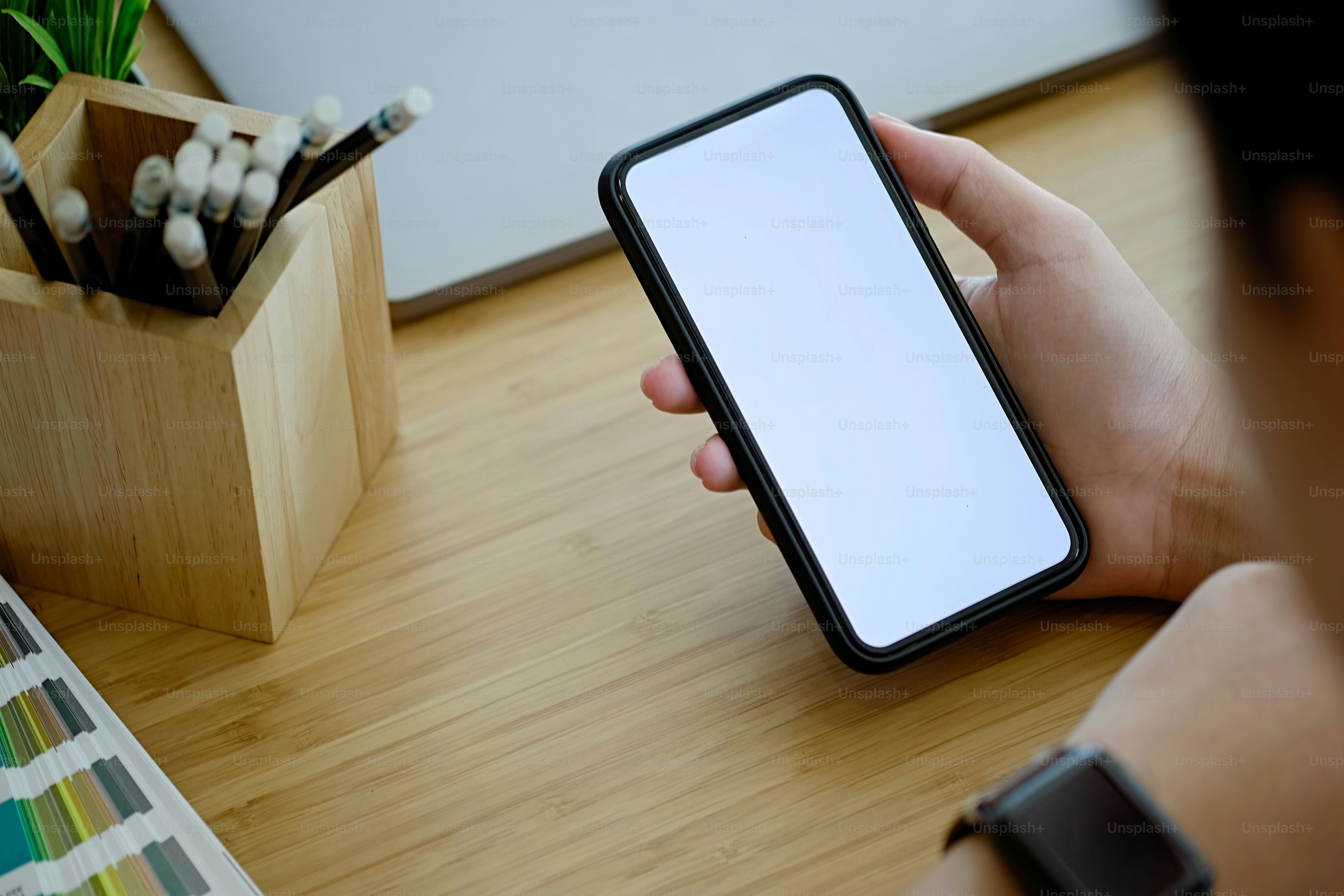 High angle shot of an unrecognizable businessman using a smart phone at ...