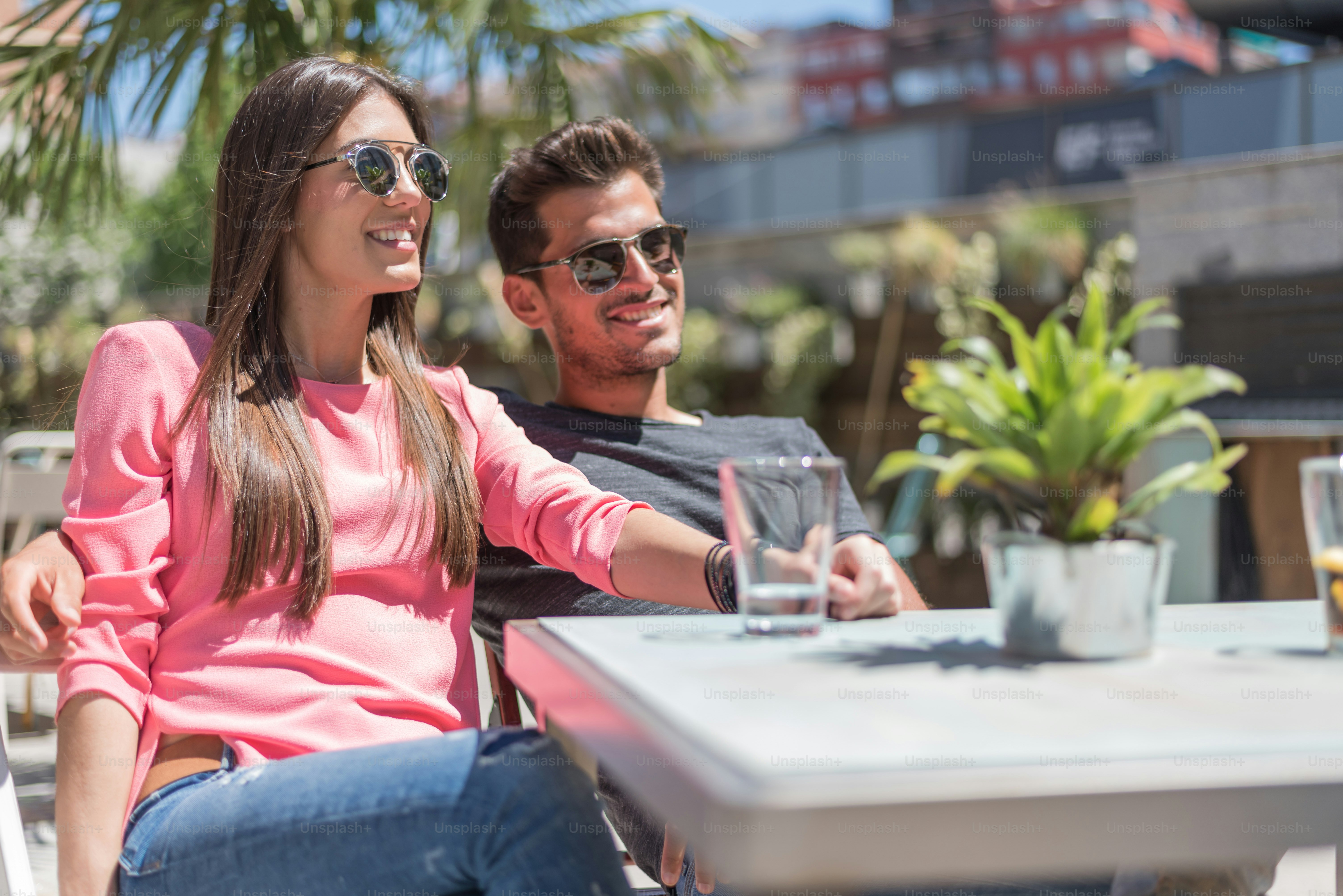 Happy young couple seating relaxed in a restaurant terrace photo ...