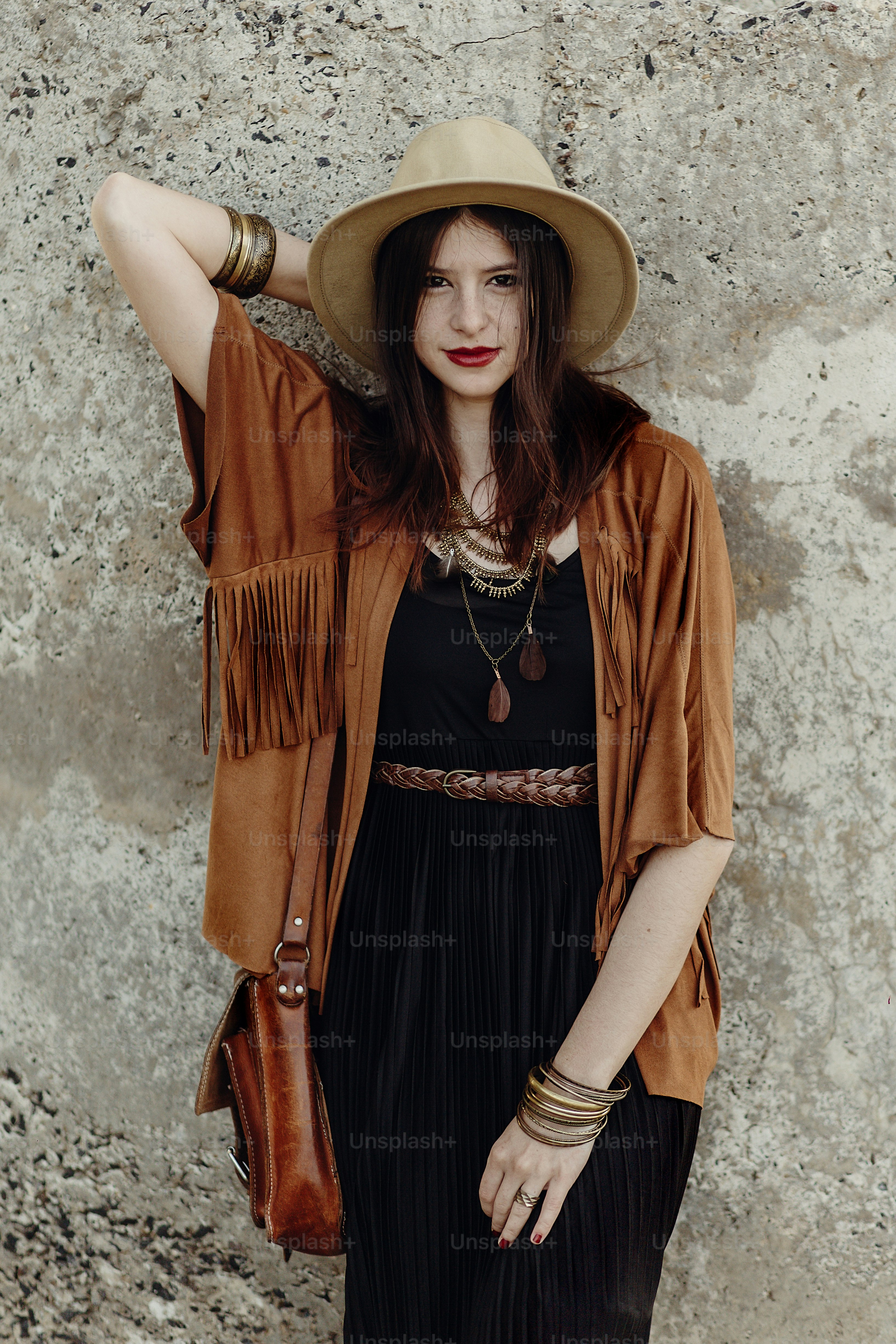 Stylish boho woman with jewelry posing at rock wall. beautiful hipster ...