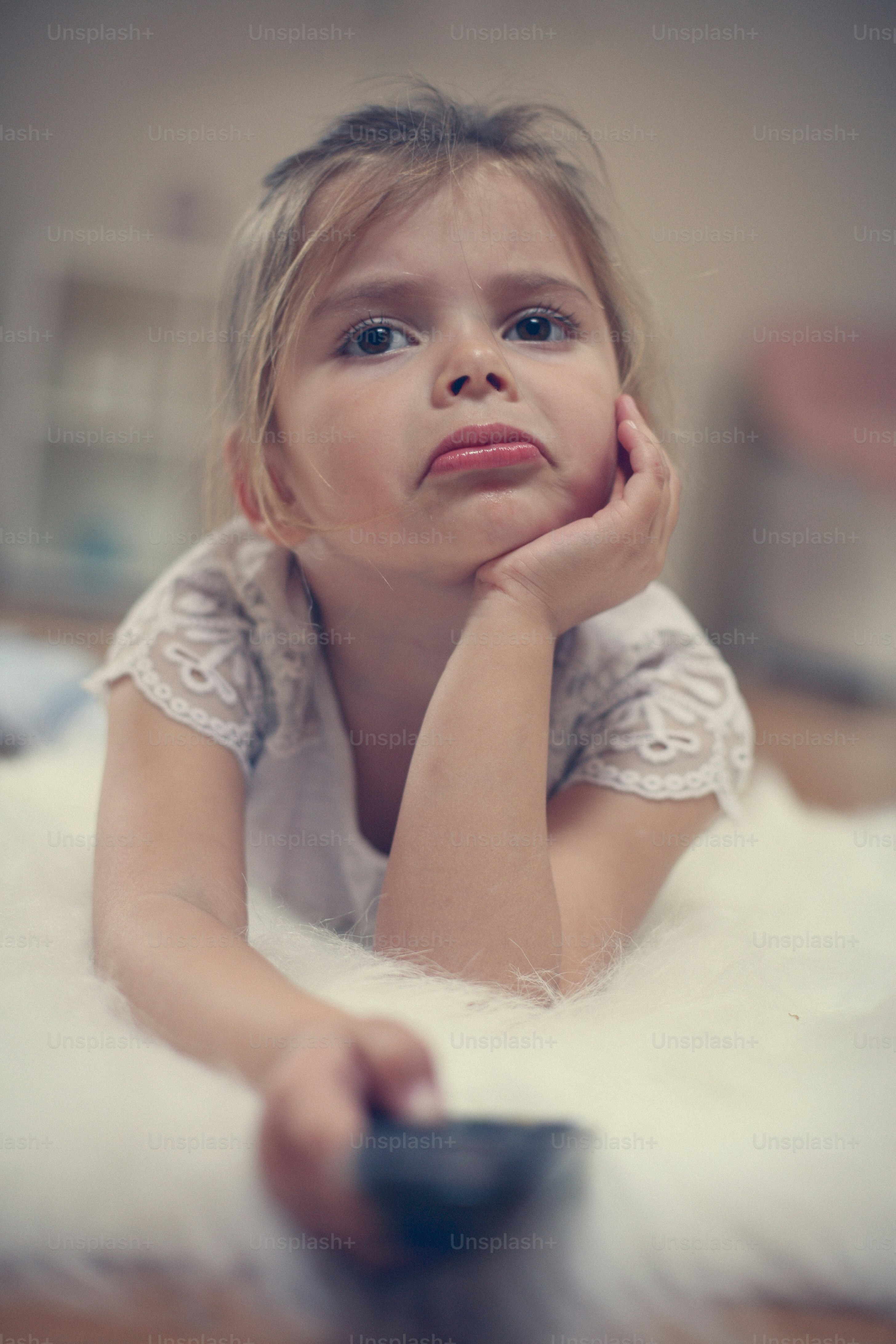 There is nothing interesting on TV. Little girl. photo – Portrait Image ...