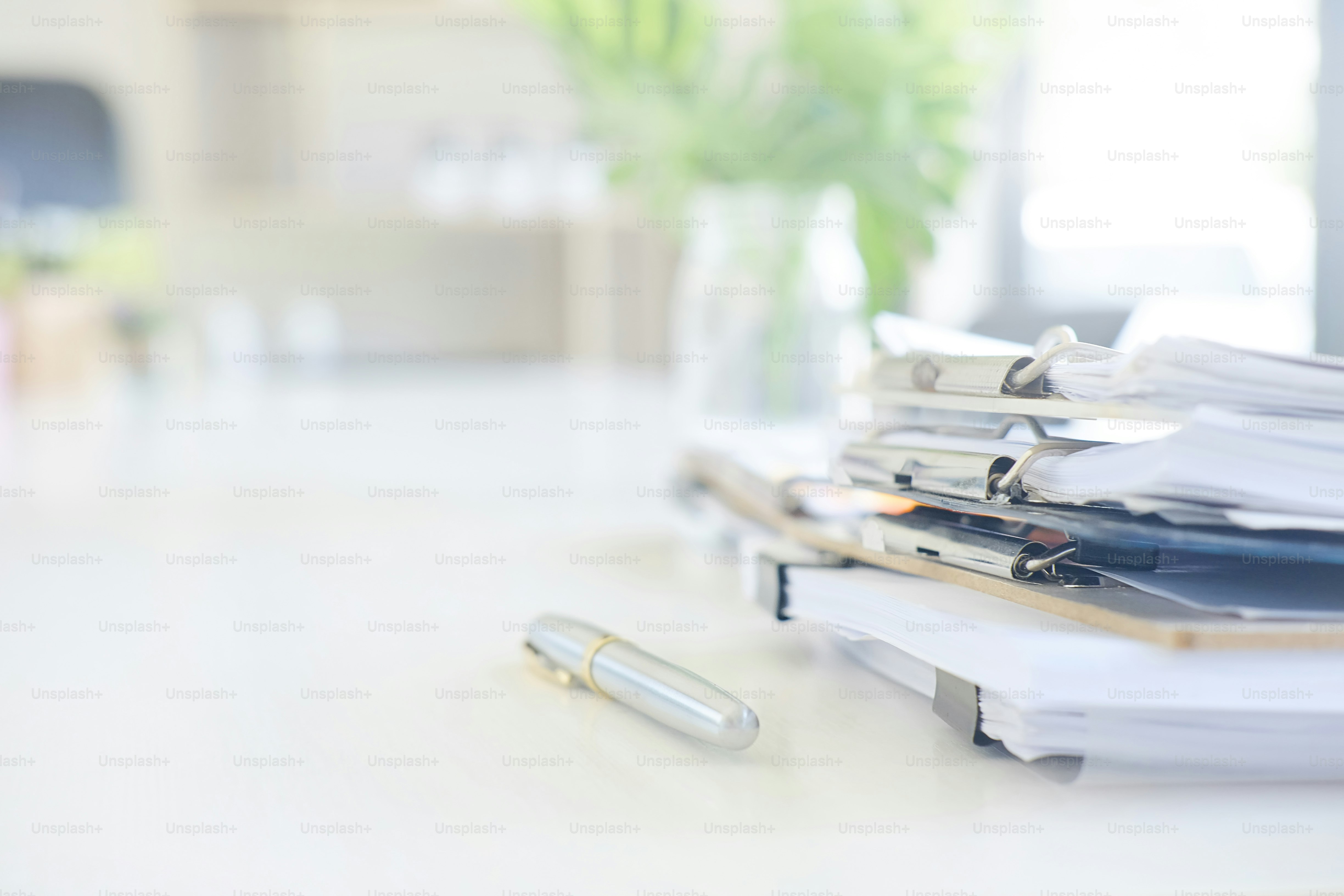 Stack of paper files and pen business equipment on office table. photo ...