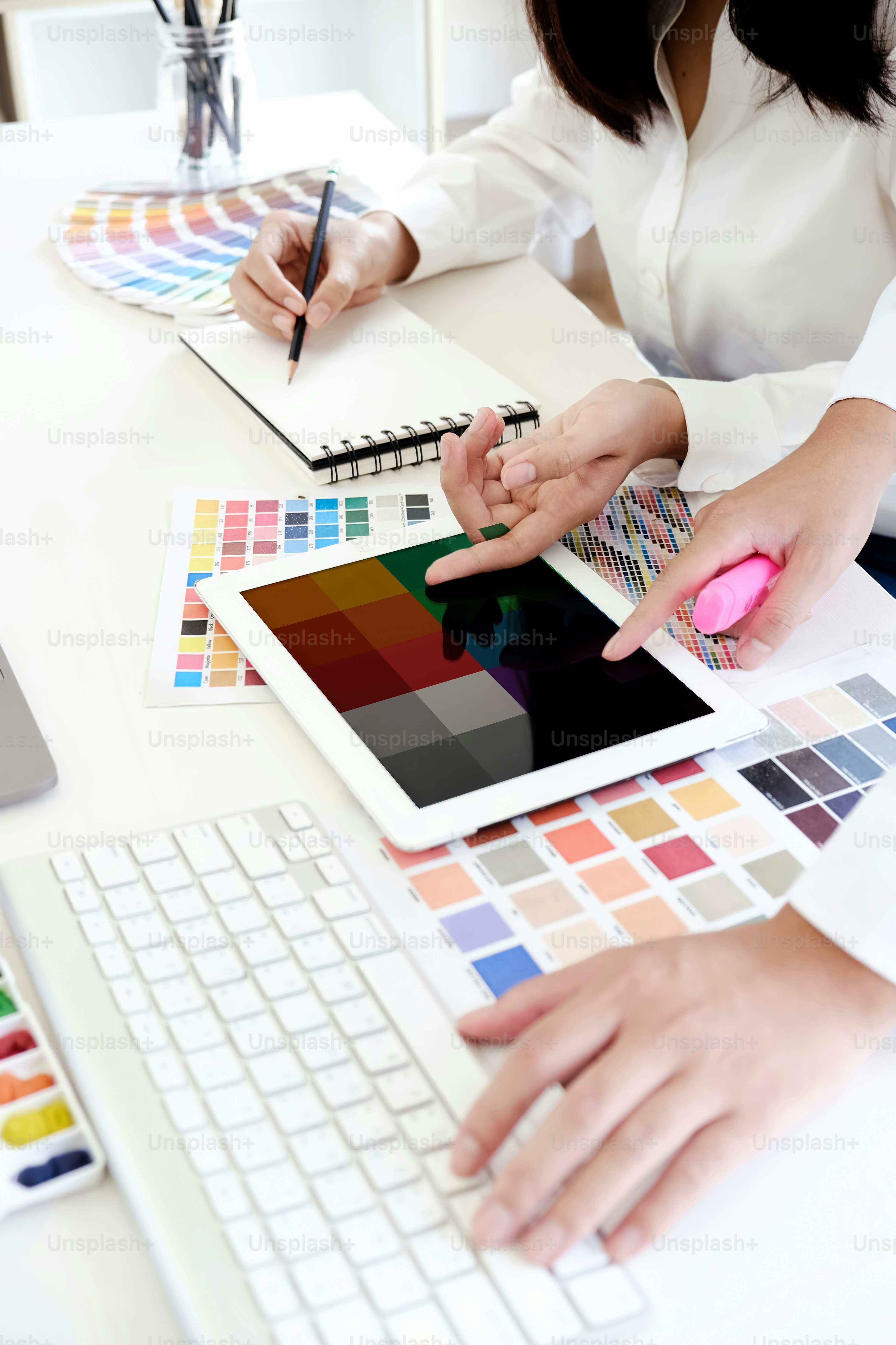 Team of creative designers working with tablet for new project in a ...