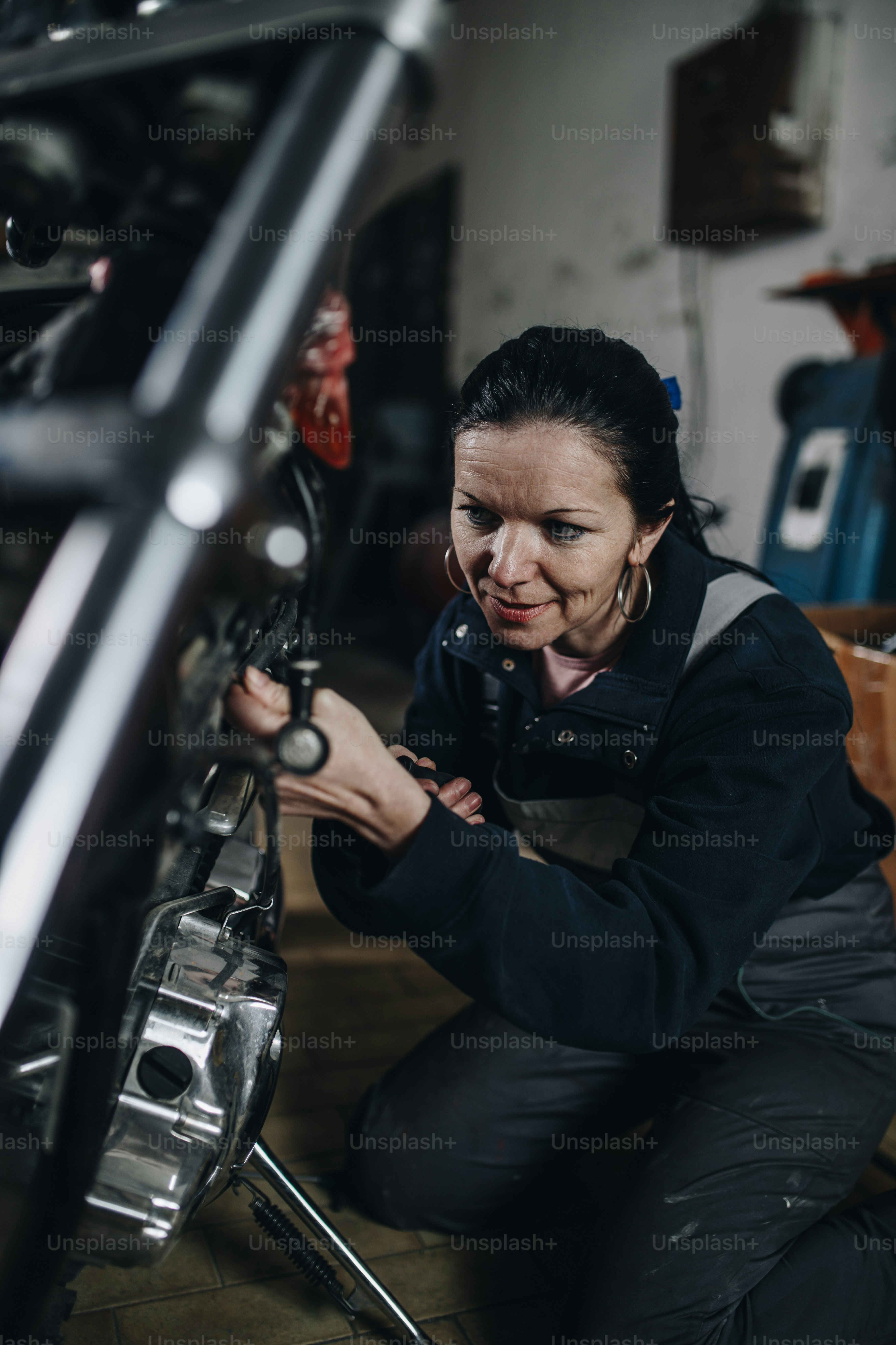 Young man doing hard job in car and motorcycle repair shop. photo ...