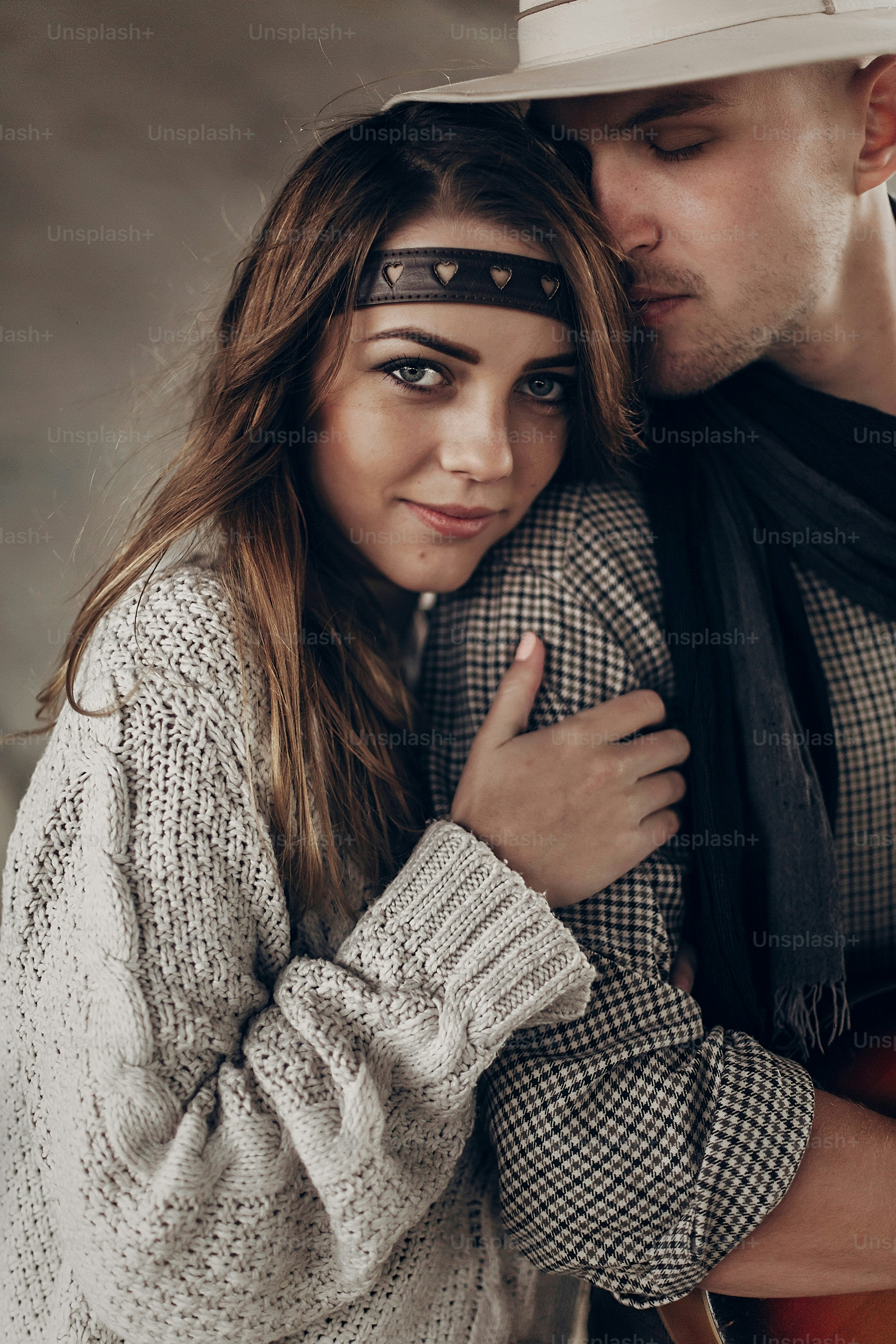 Handsome cowboy man in stylish scarf hugging beautiful hipster woman in ...