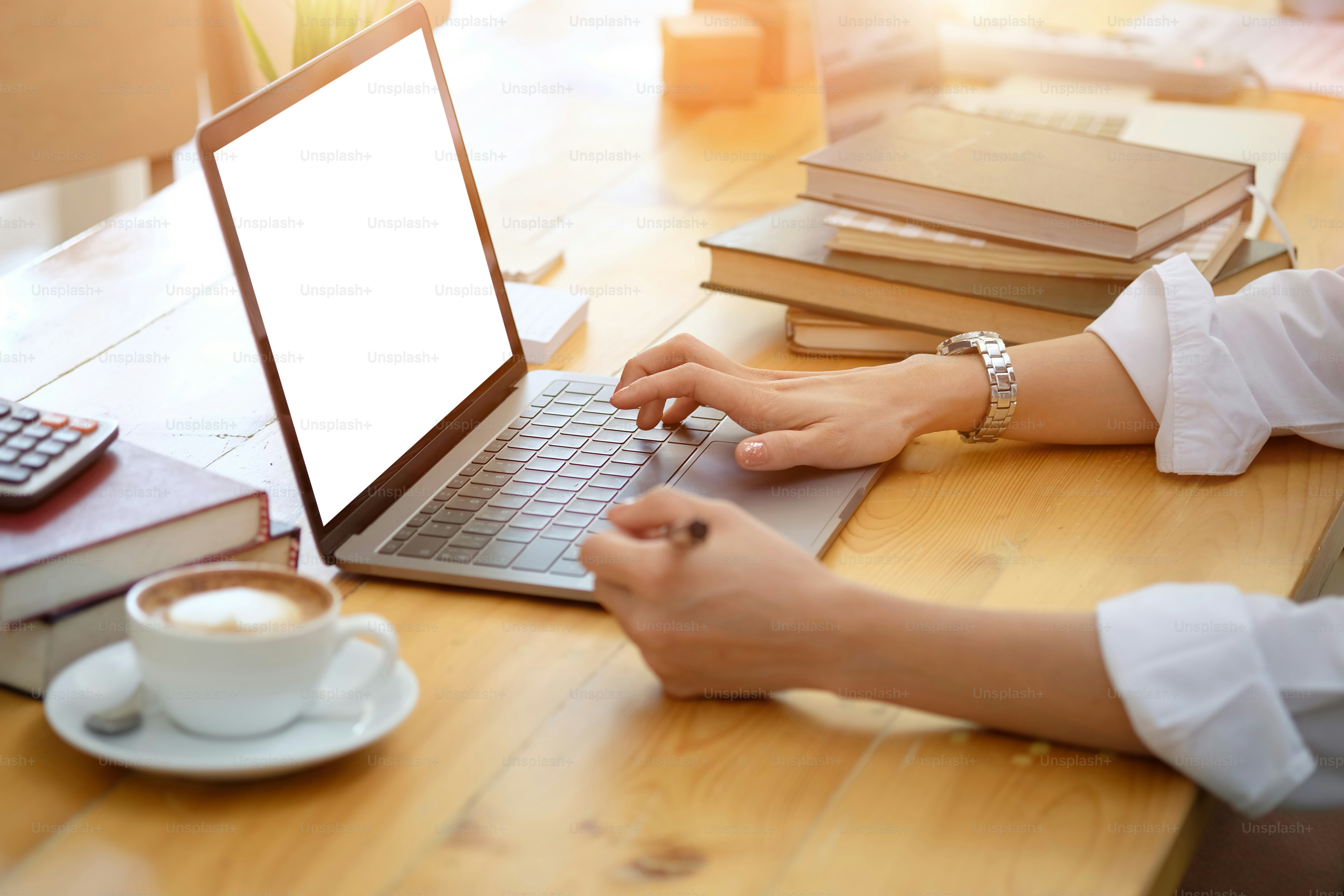 Businesswoman working on laptop at workplace in office or co-working ...