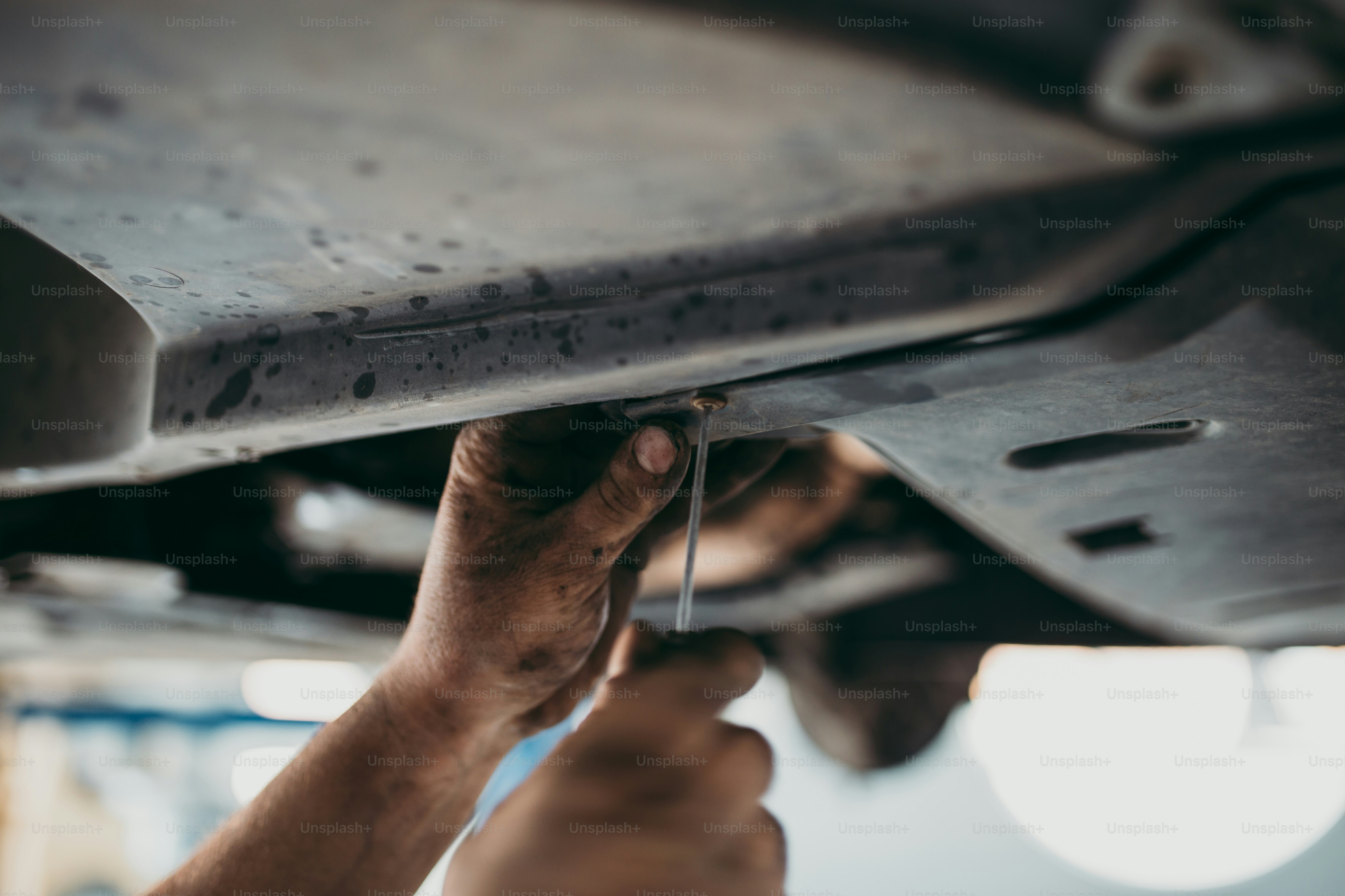Close up shot of worker hands fixing car ball bearing and conveyor belt ...