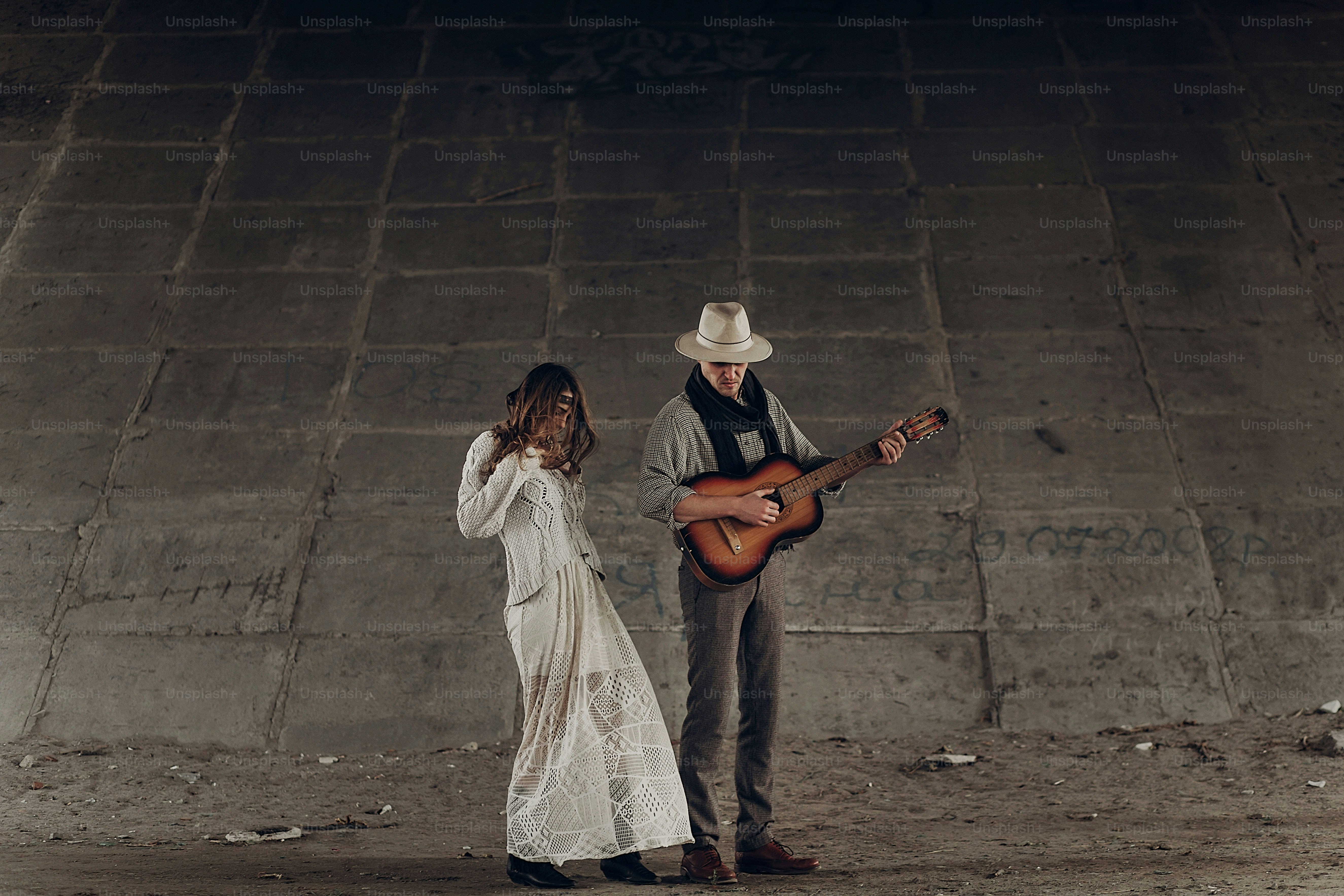 Stylish gypsy woman in boho clothes dancing near handsome man, cowboy ...