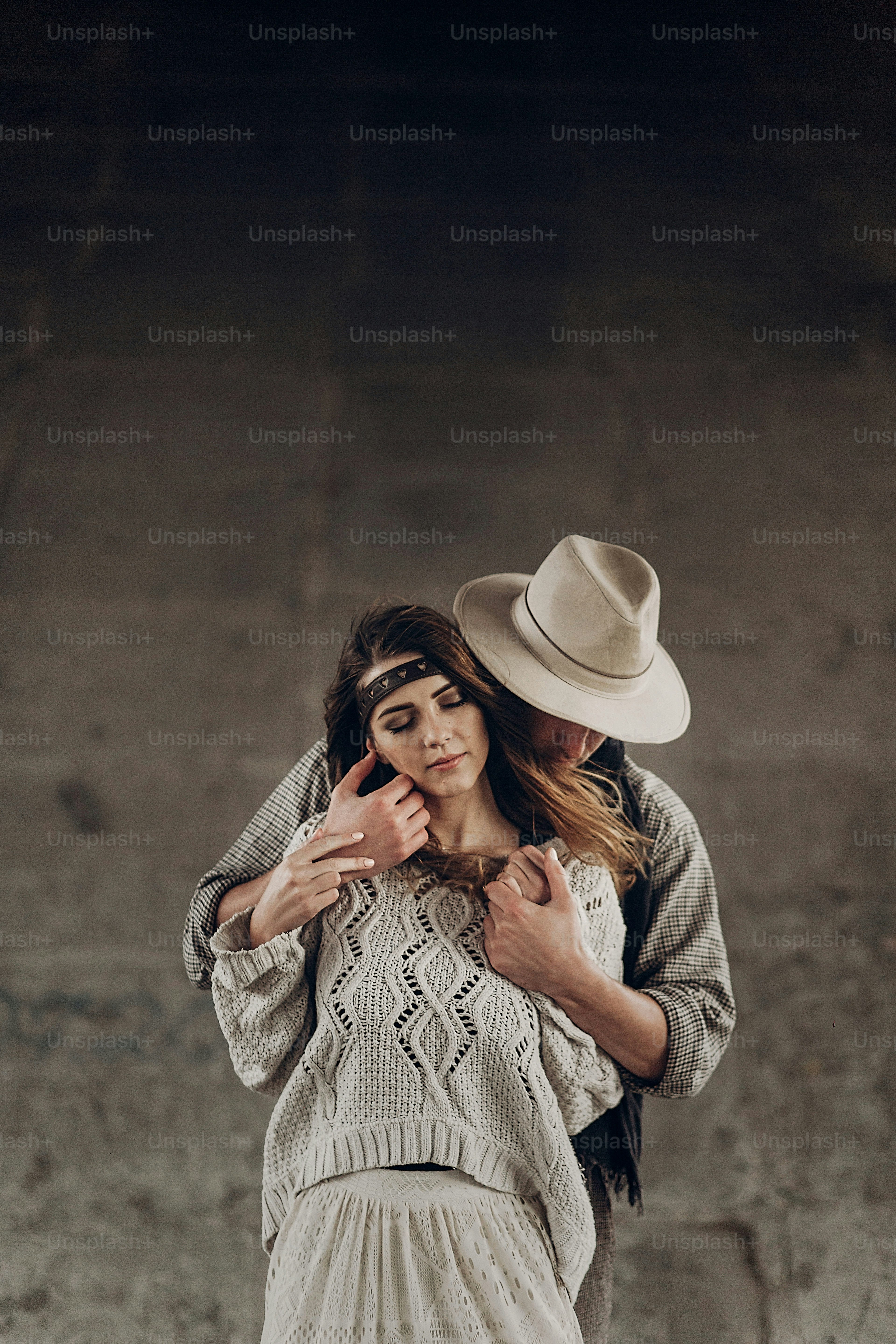 Handsome cowboy man in white hat touching cheek of beautiful boho gypsy ...