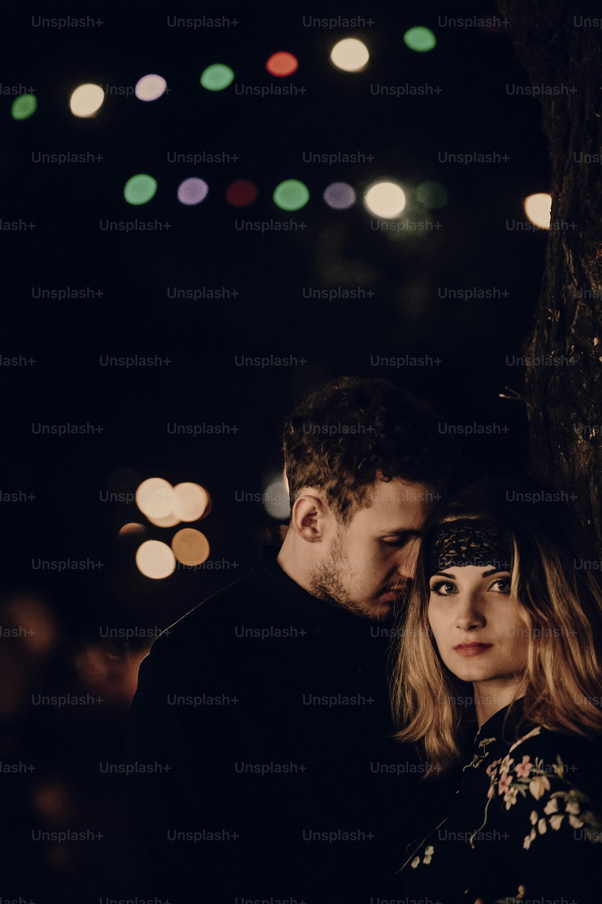 Stylish gypsy couple in love kissing hugging in evening city street ...
