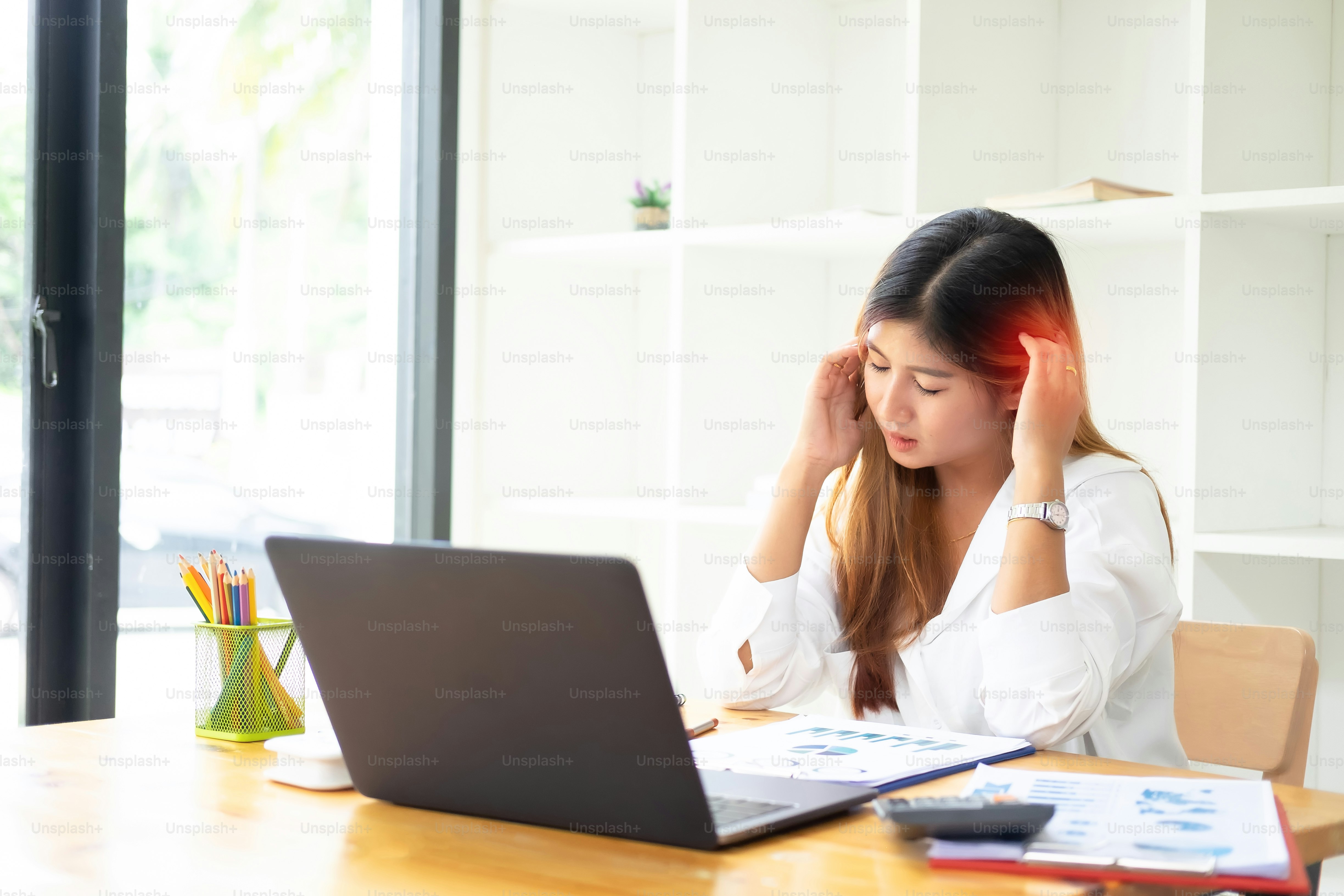 Asian businesswoman touching massaging stiff head to relieve pain in ...