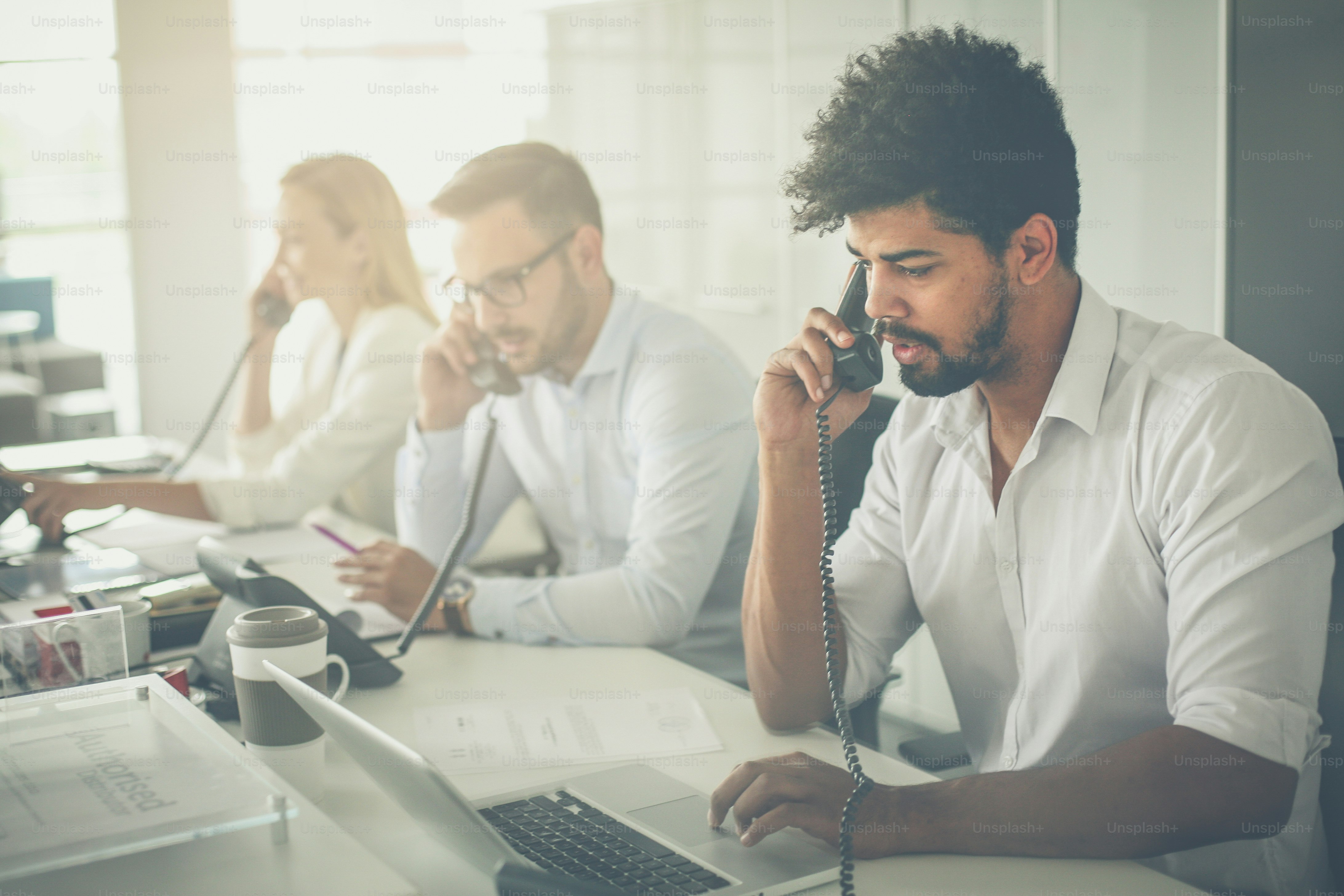 People in call center talking on Landline phone. Business people. photo ...