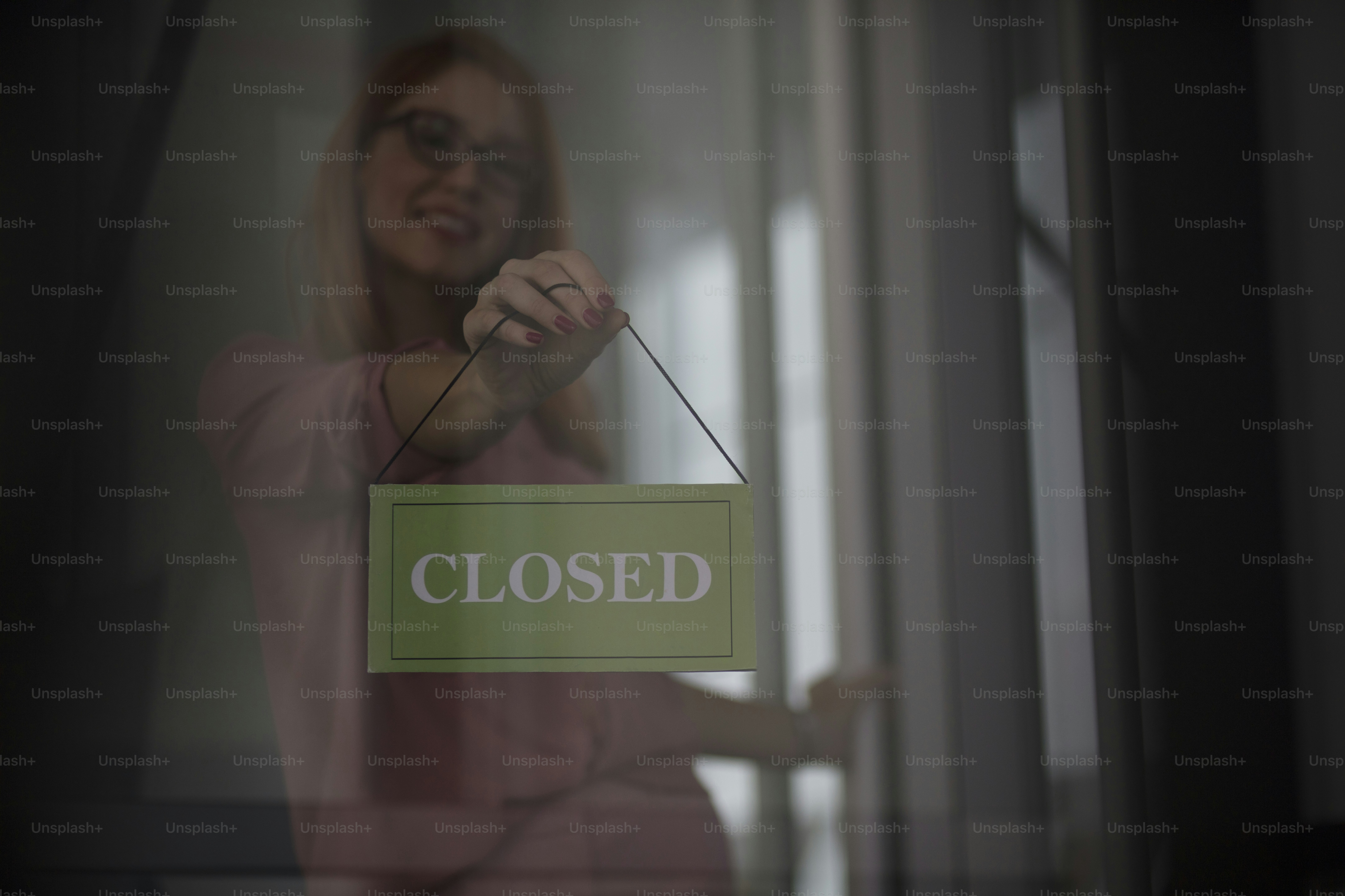Store owner turning closed sign In shop doorway. photo – Closed sign ...